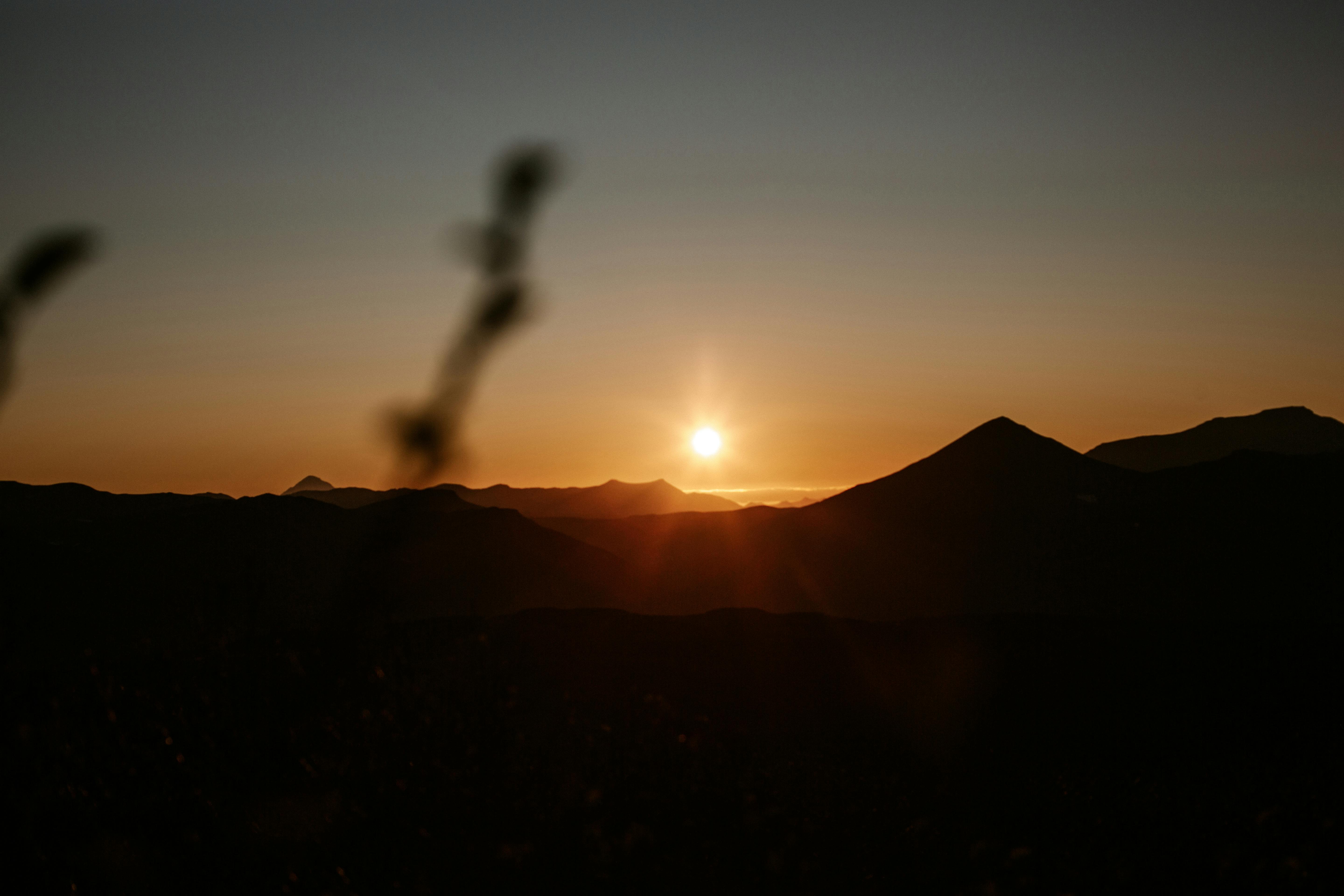 Figure of hiker with upward ray in dark · Free Stock Photo