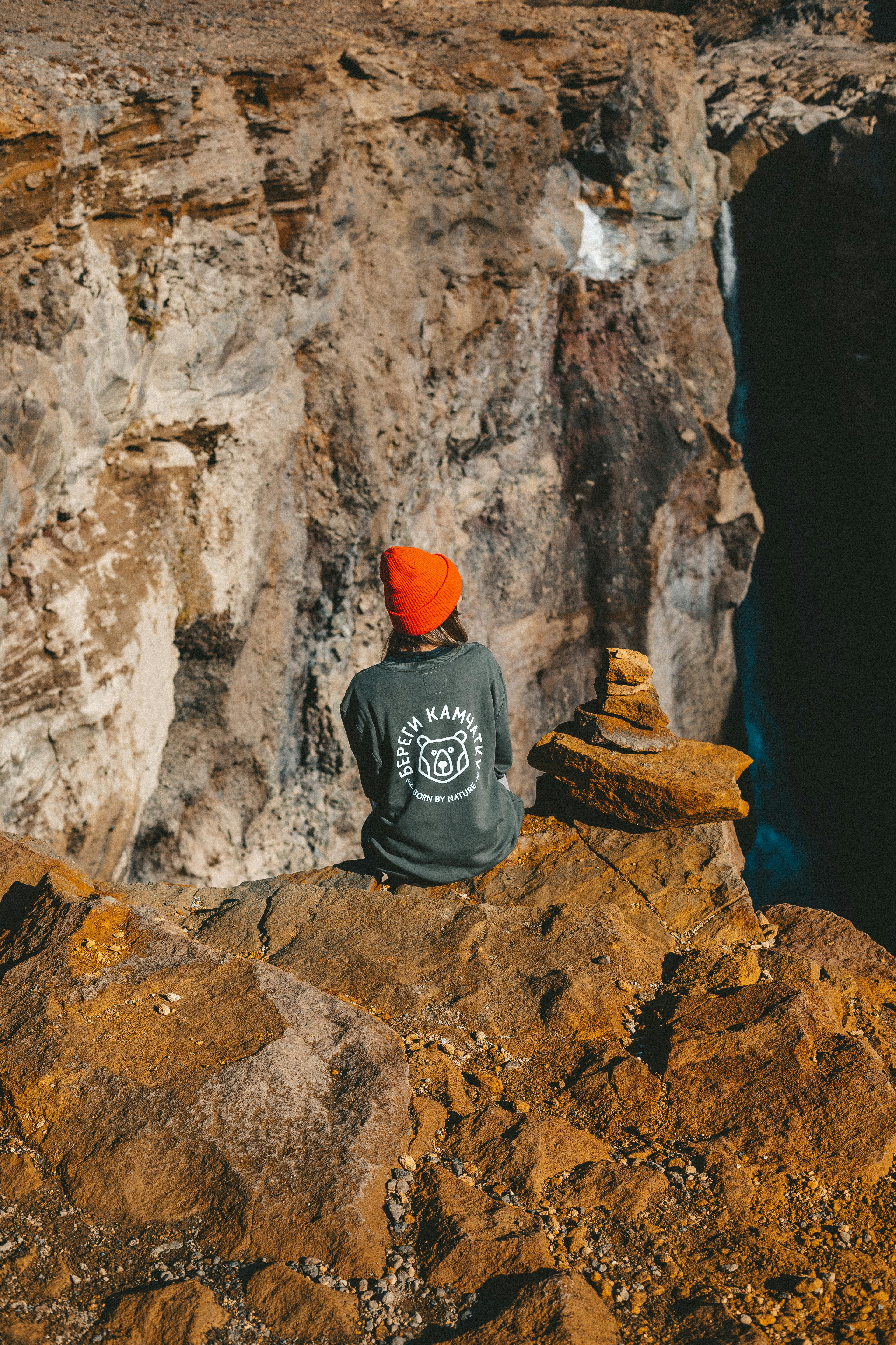 A Person Sitting on the Edge of the Cliff · Free Stock Photo