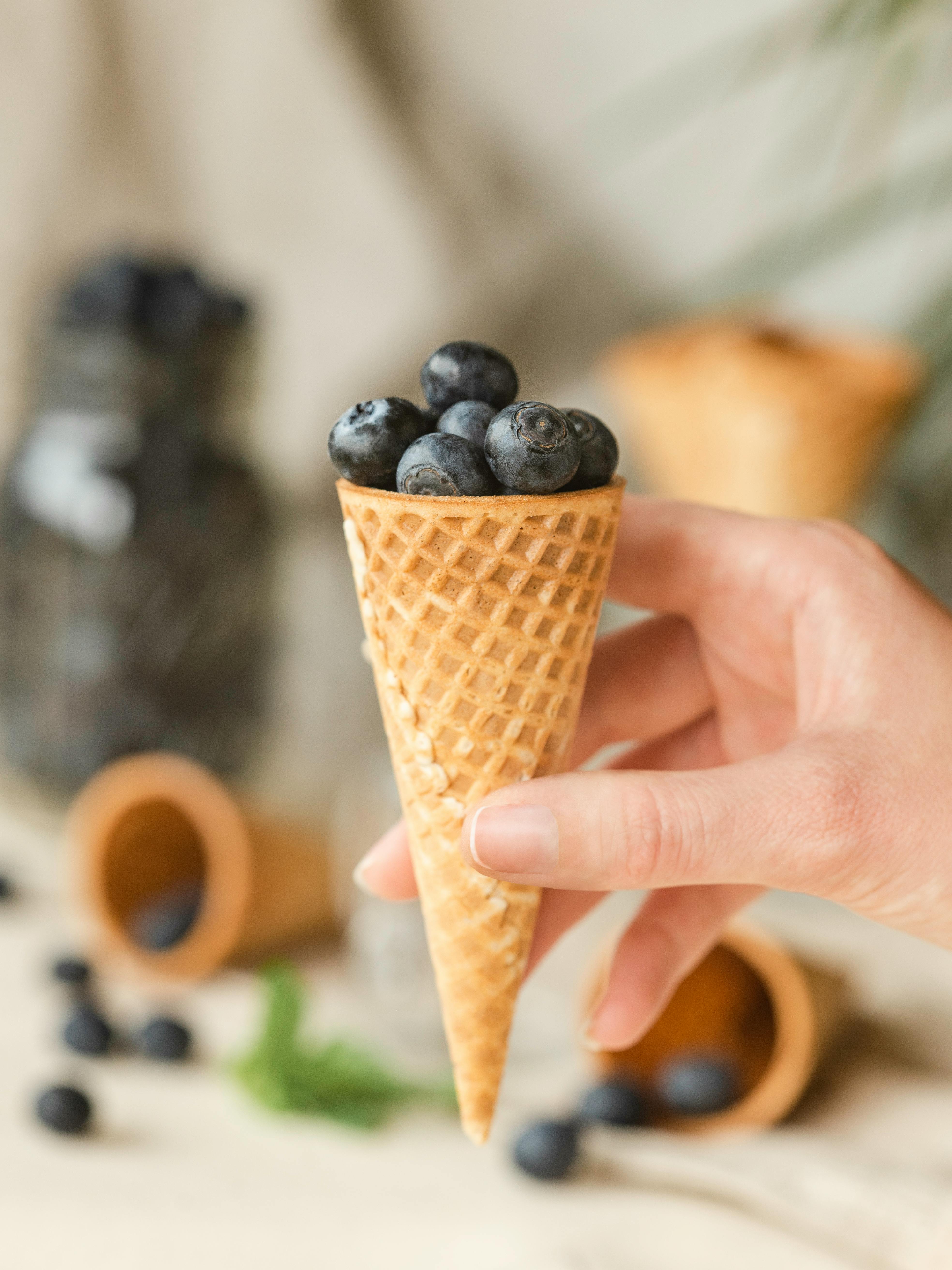 Container with delicious waffle cones in restaurant · Free Stock Photo