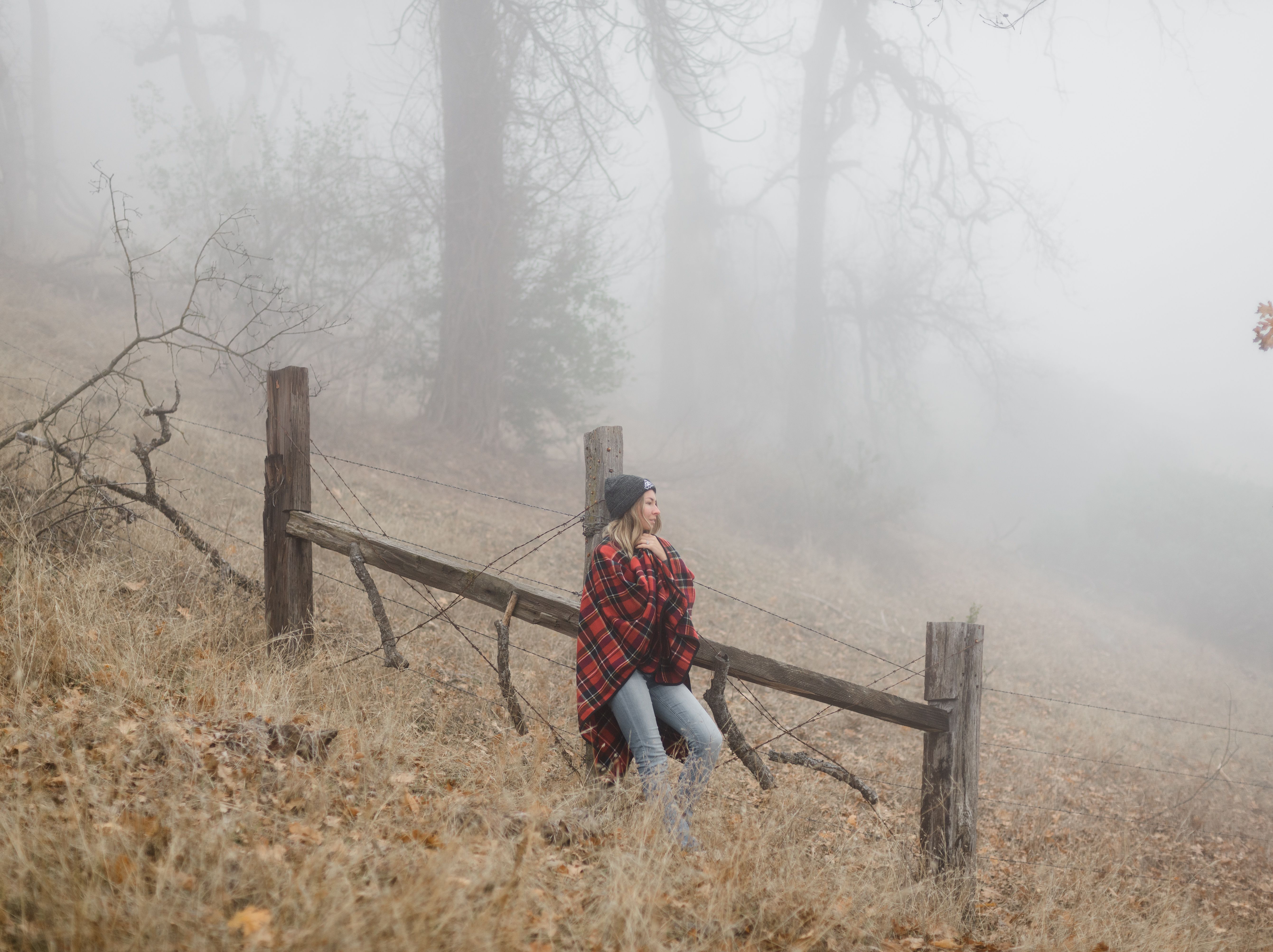 Young woman standing near fence in countryside · Free Stock Photo