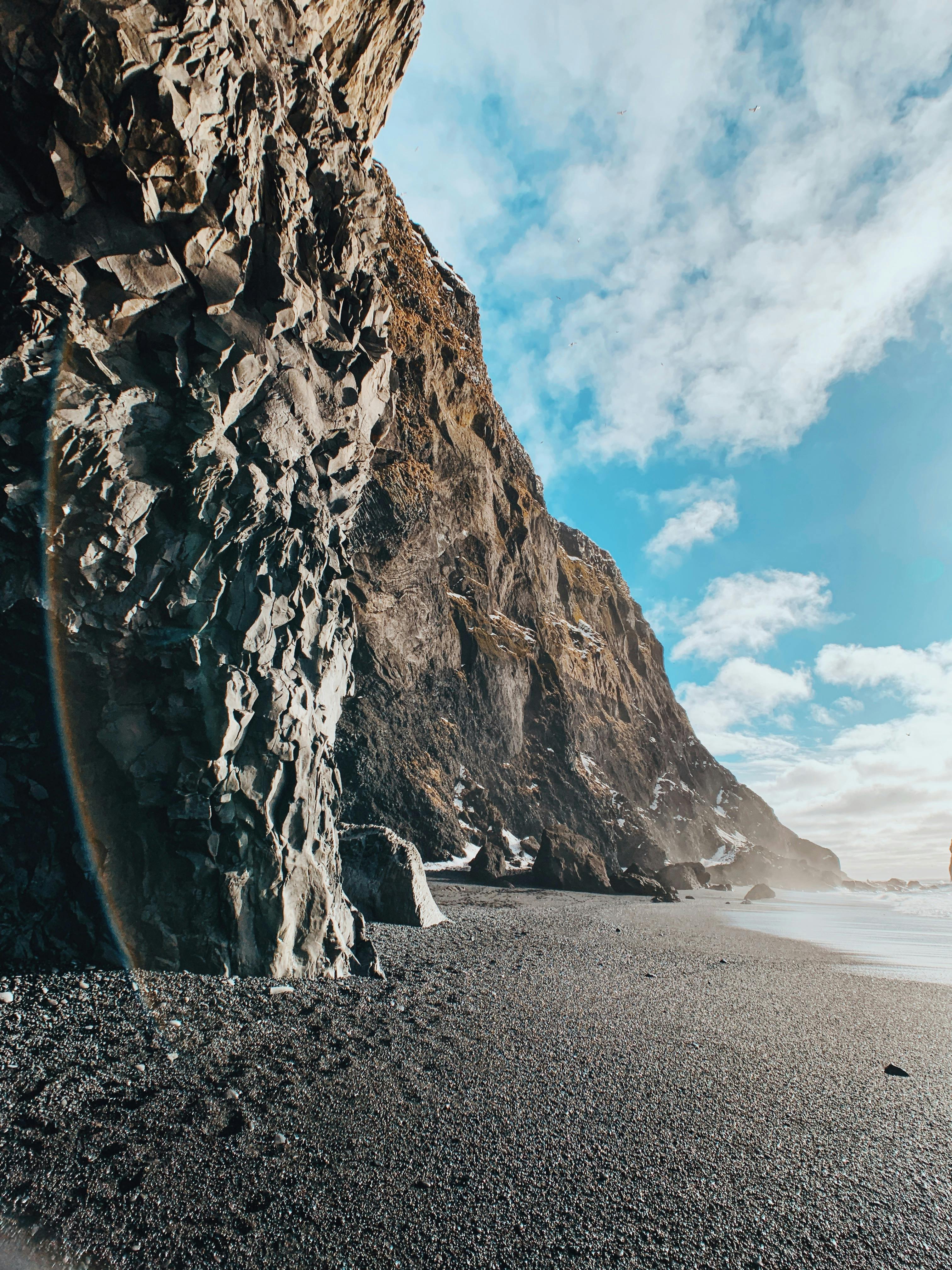 Rocky coast with cliff near sea · Free Stock Photo