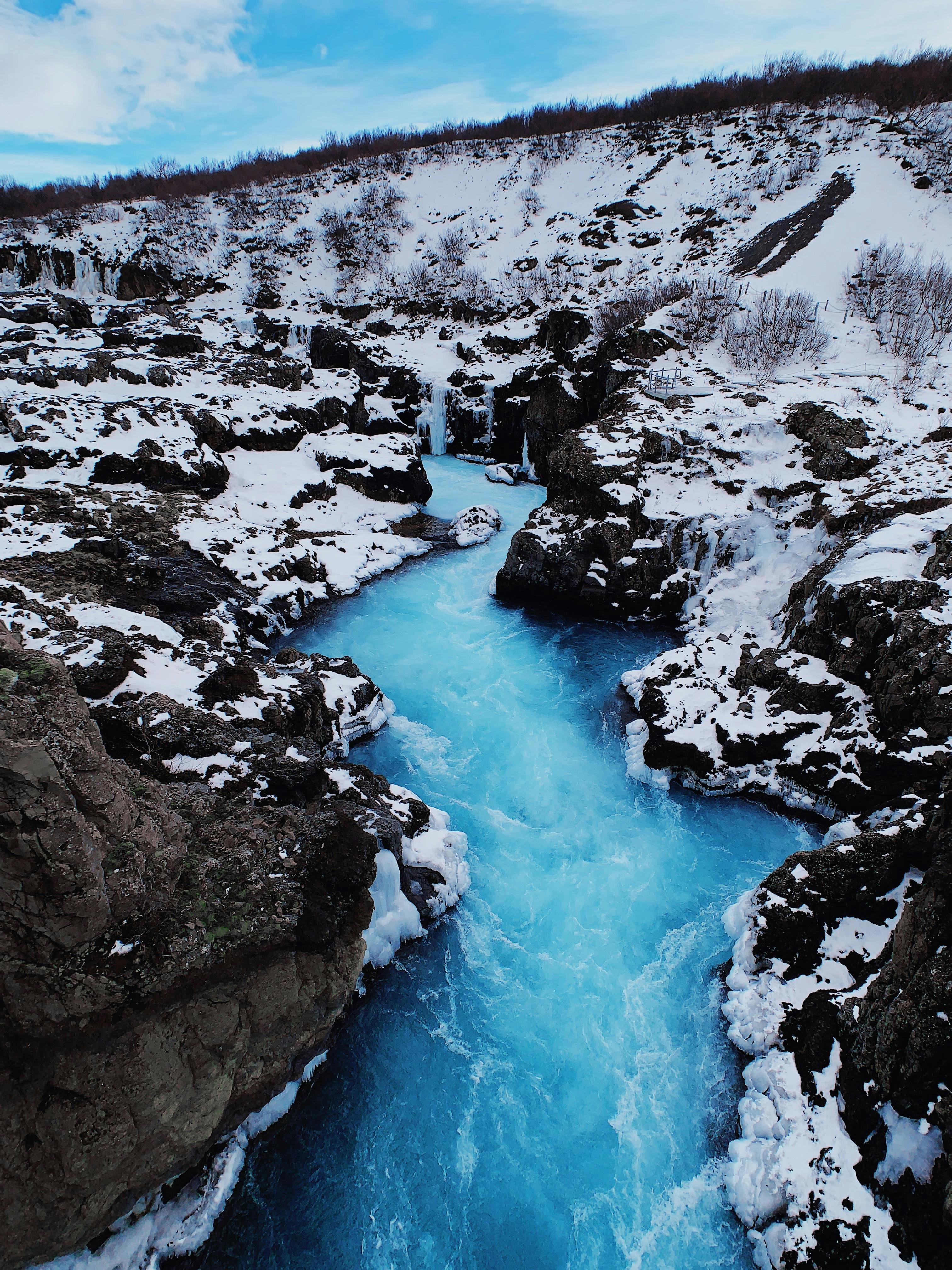 Turquoise river flowing among rocks · Free Stock Photo