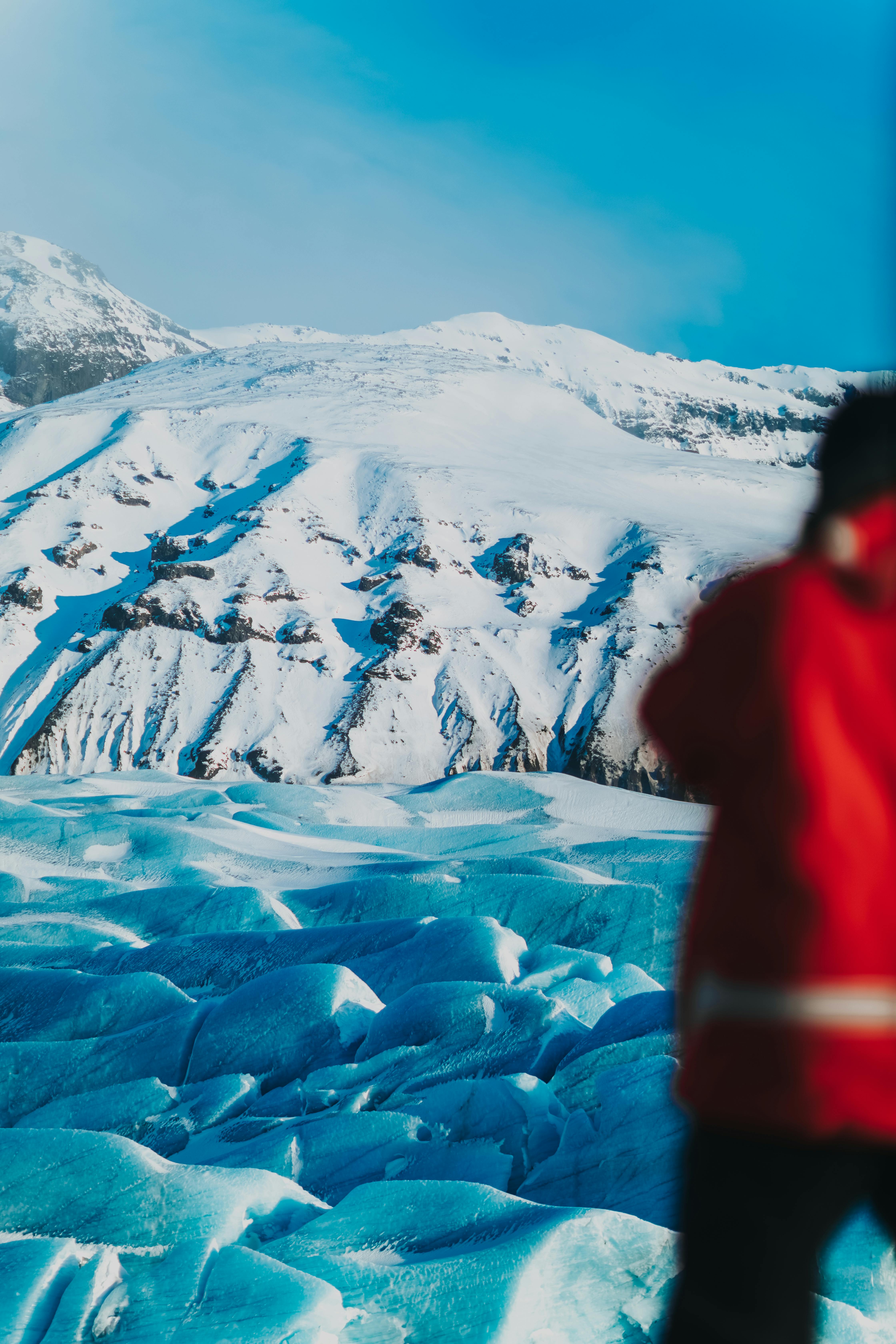 Crop man sitting on cliff · Free Stock Photo