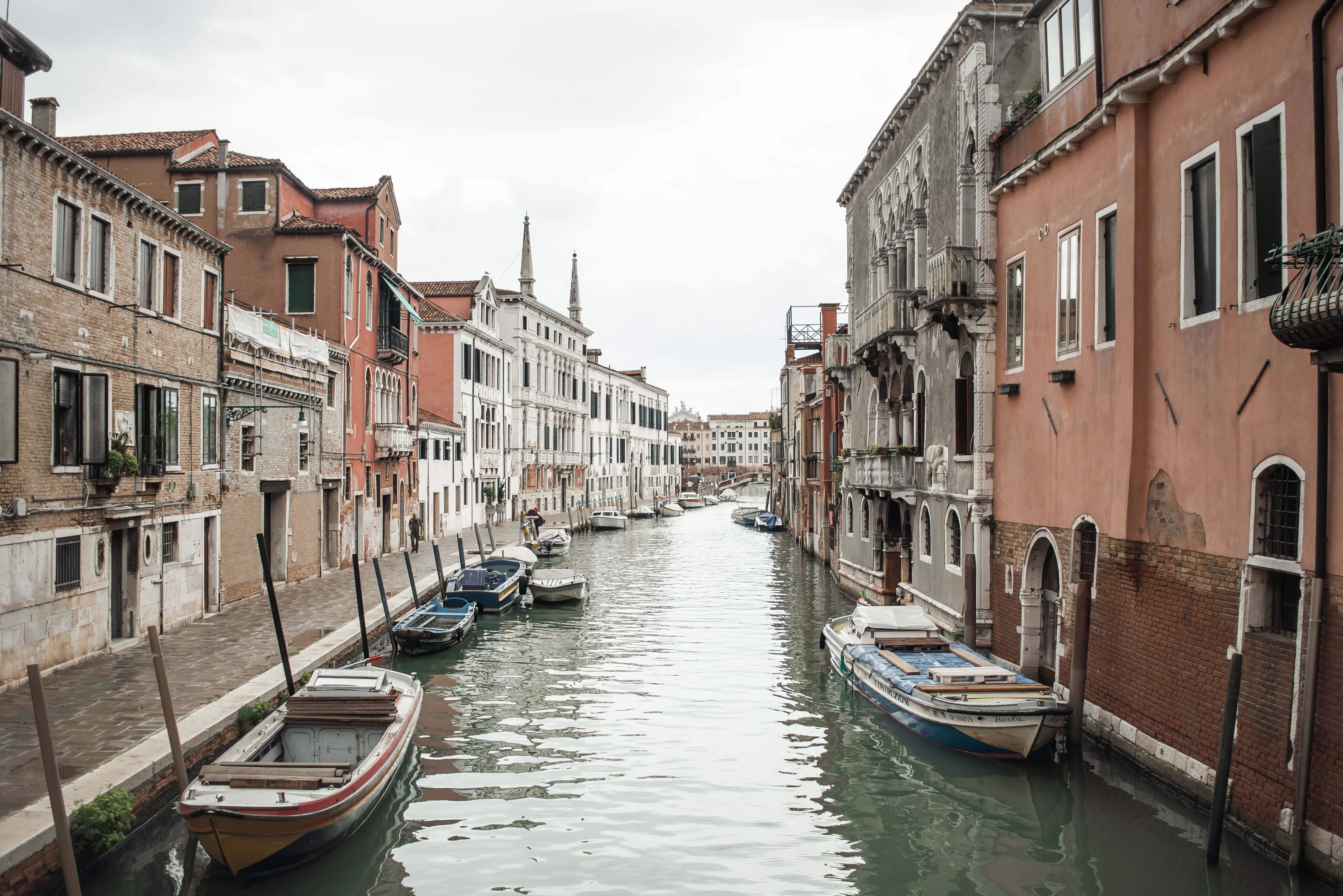 Waterway with gondolas amidst old medieval buildings · Free Stock Photo