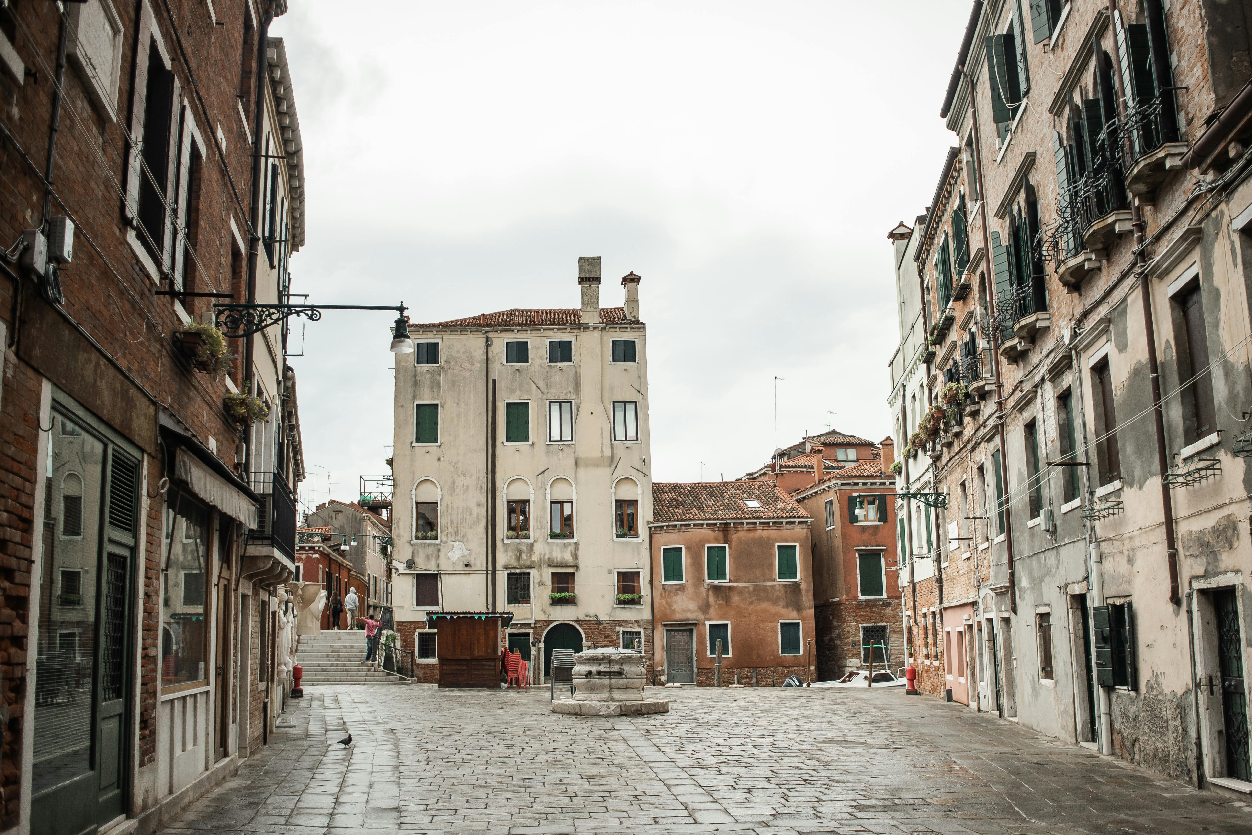 Old city street with shabby stone buildings · Free Stock Photo