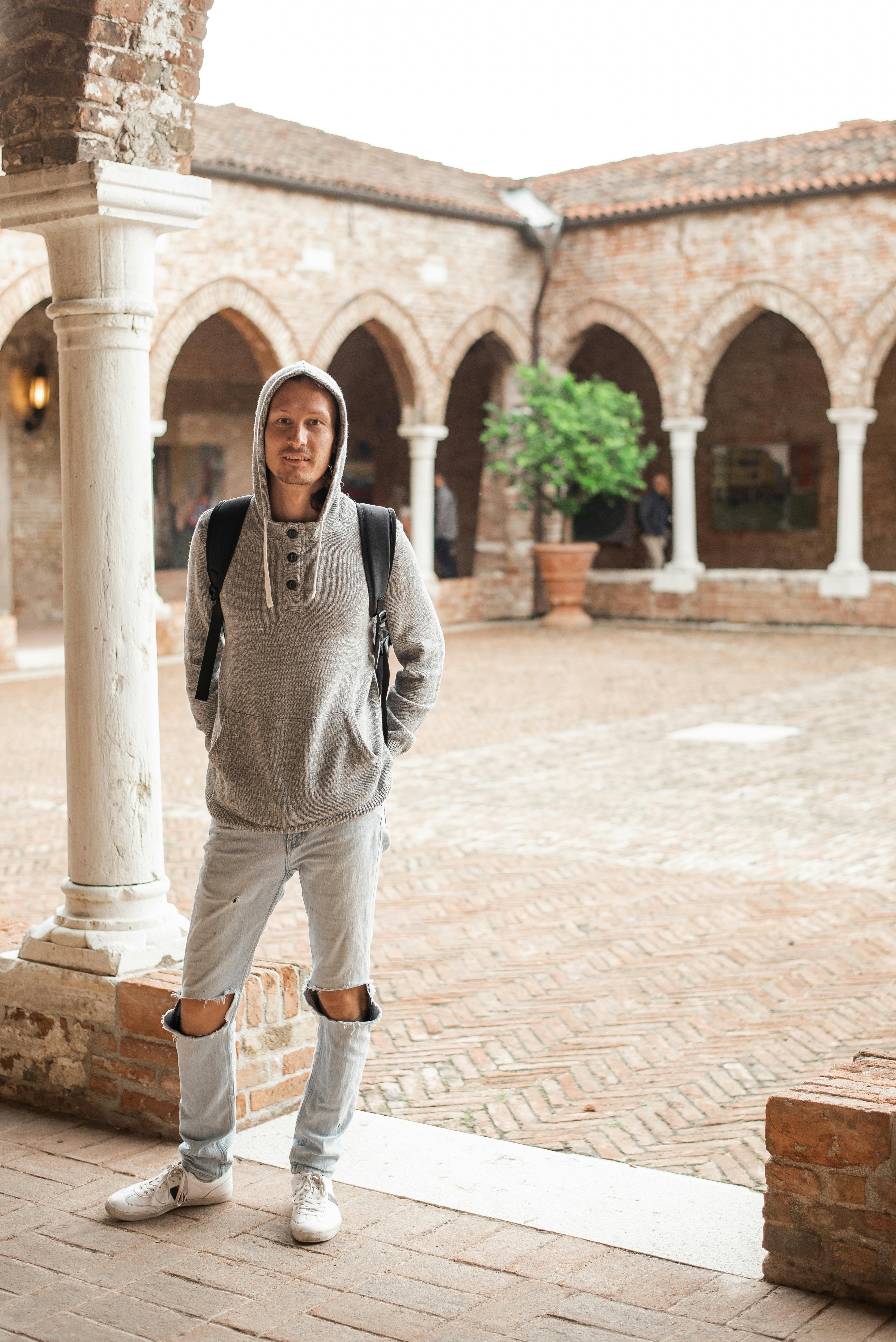 Man in old building with cozy arches · Free Stock Photo