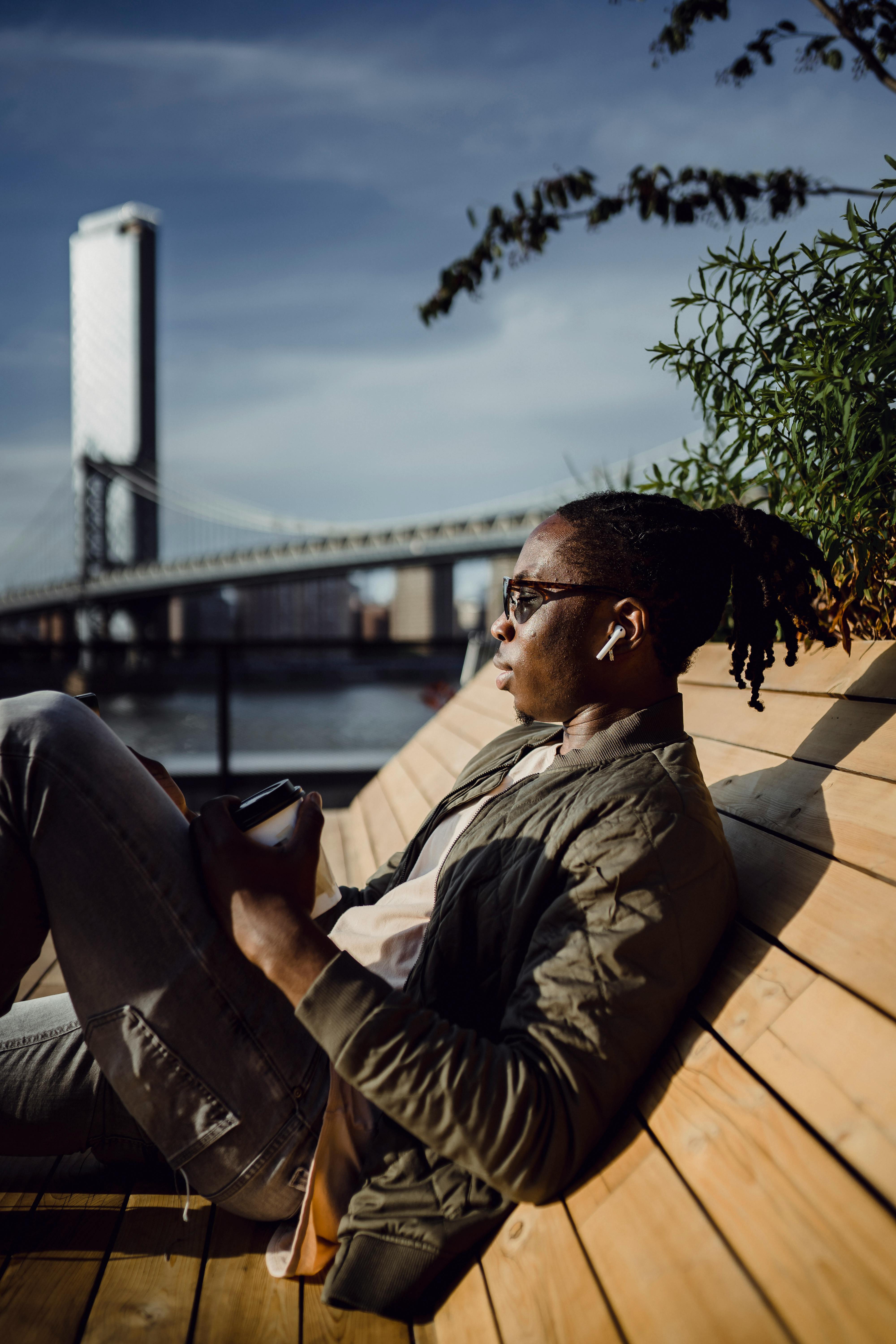 Crop anonymous man listening to music with boombox on street · Free ...