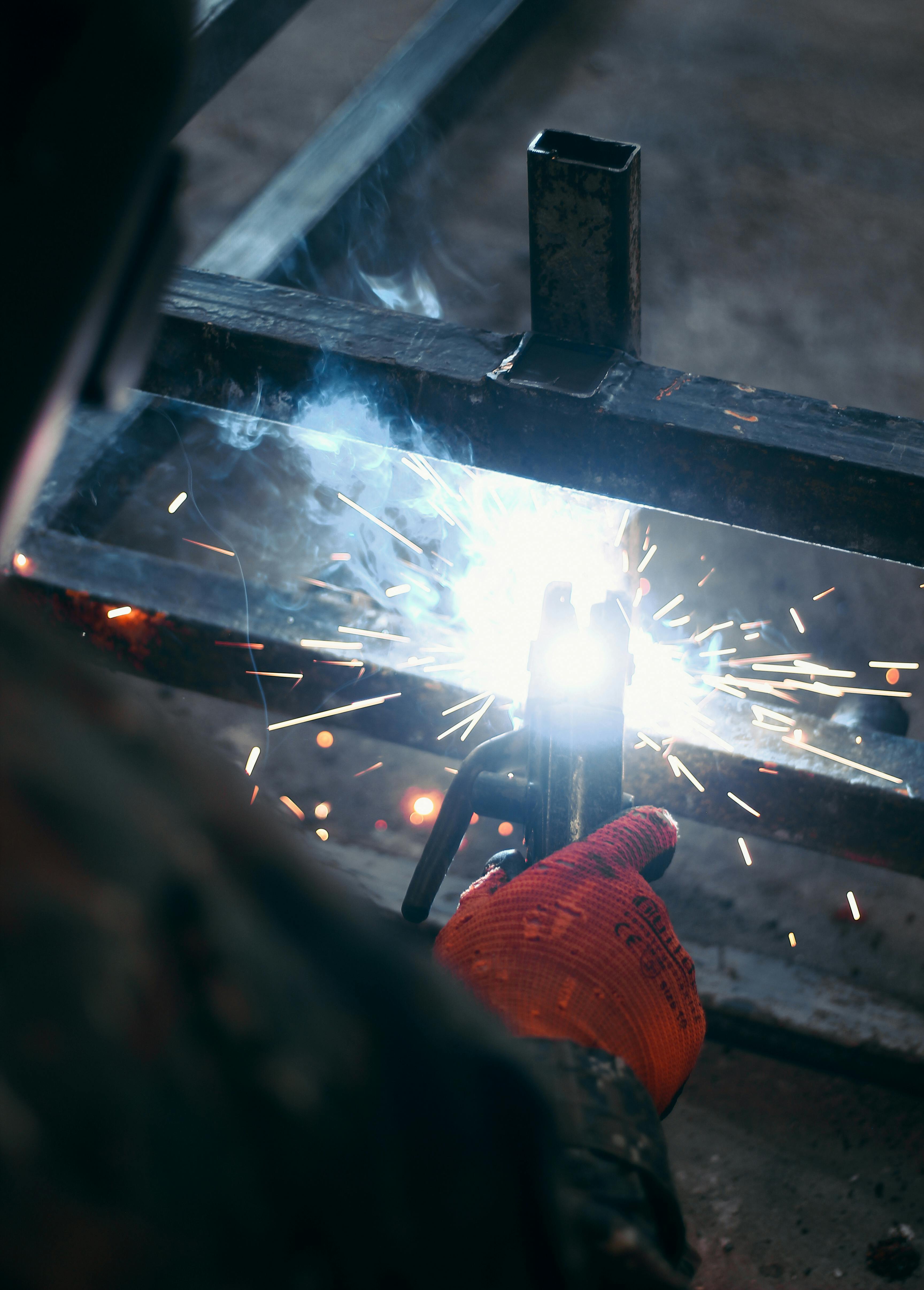 A Man Welding Metal · Free Stock Photo