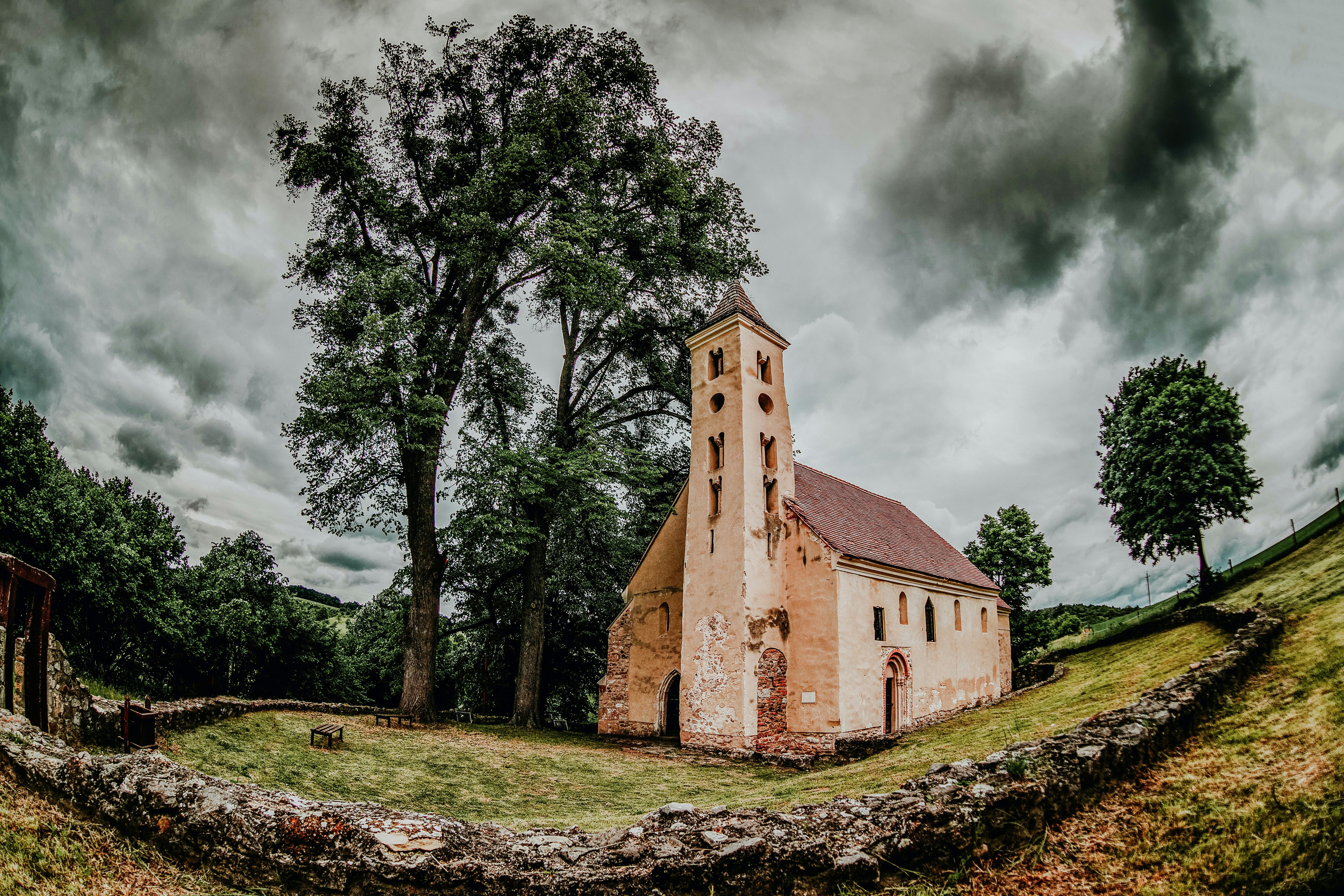 Beautiful Old Medieval Small Church Under Cloudy Sky · Free Stock Photo