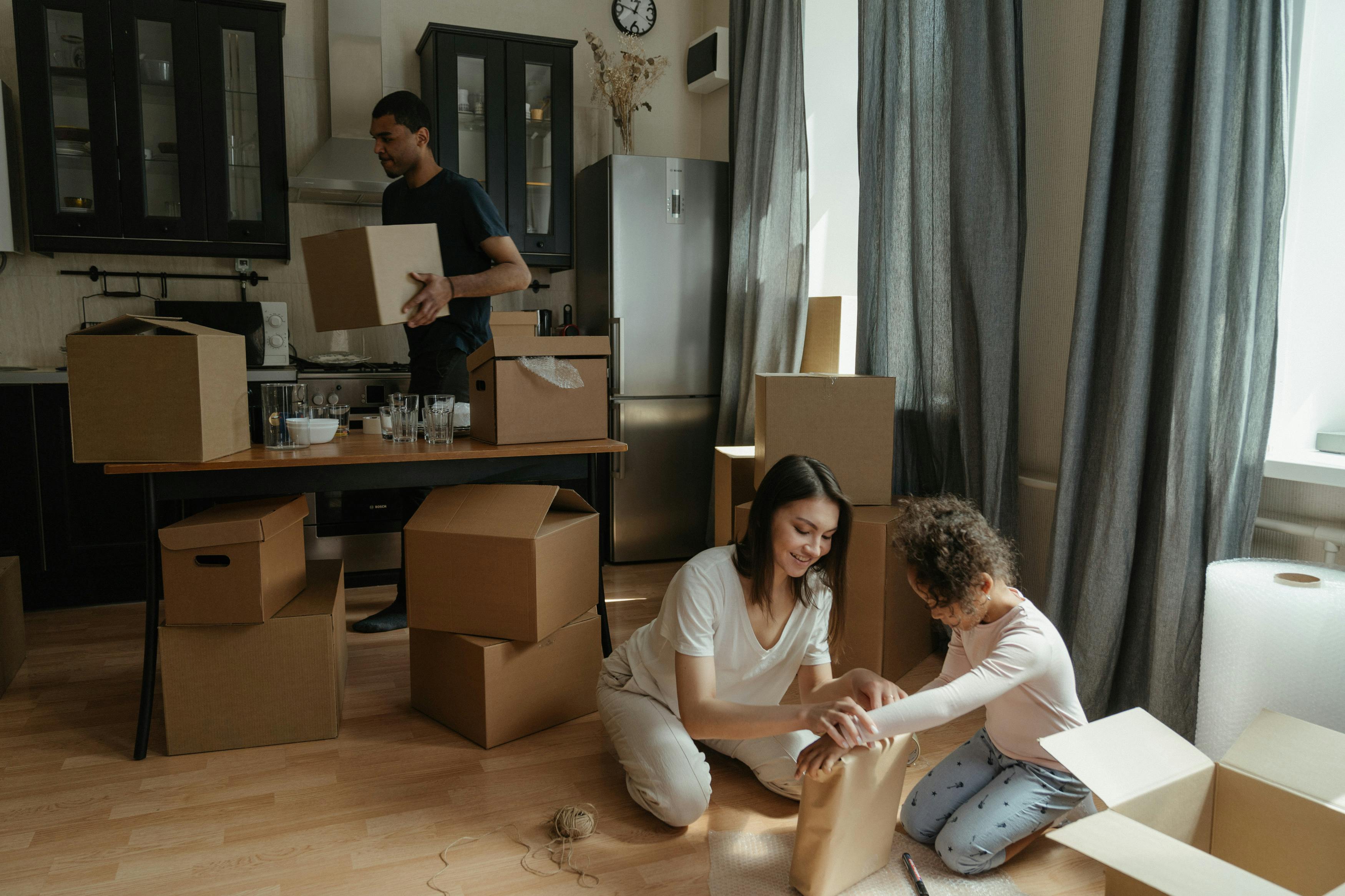 Brown Cardboard Boxes Near White Wooden Cabinet · Free Stock Photo