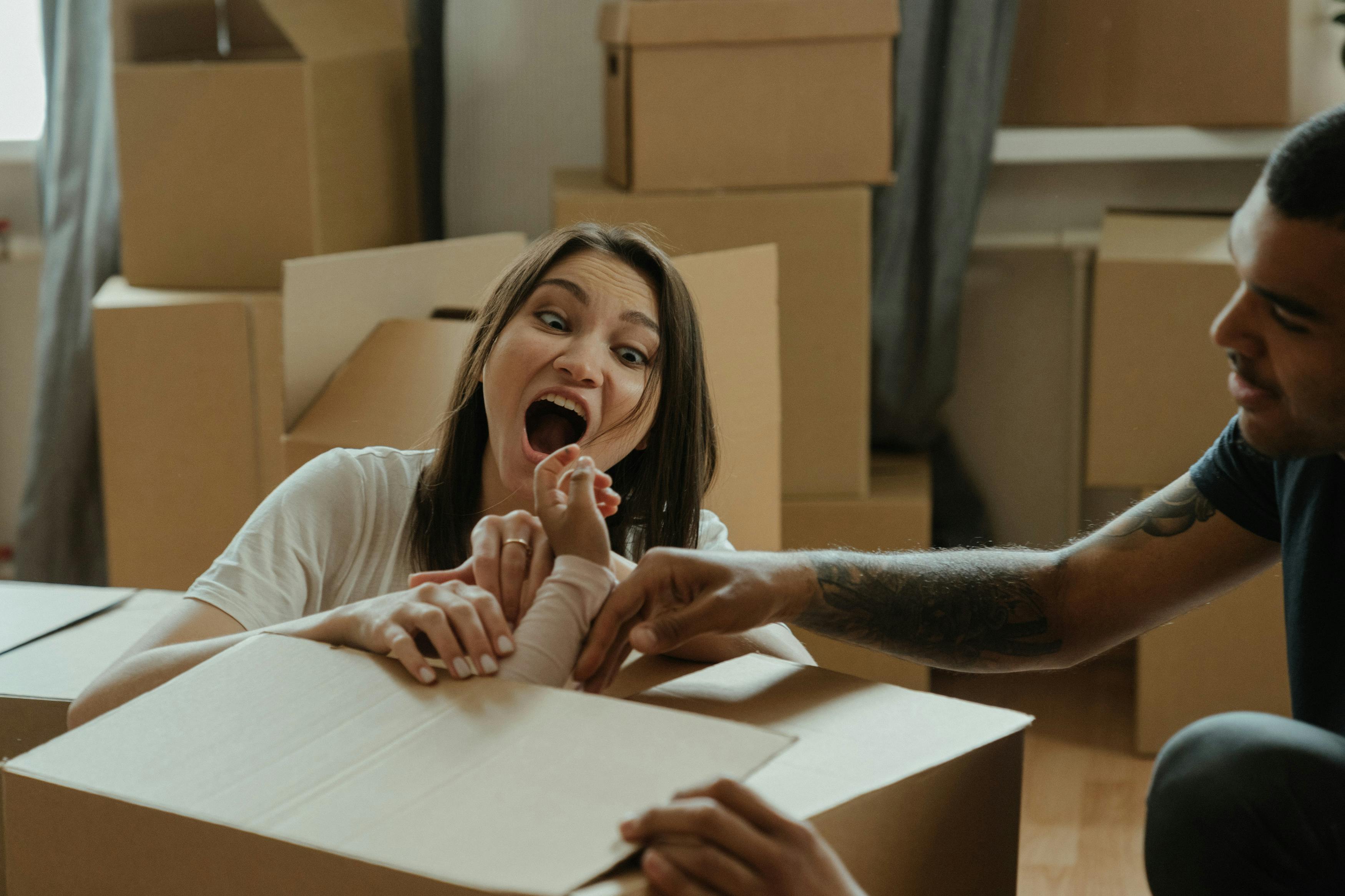 Brown Cardboard Boxes Near White Wooden Cabinet · Free Stock Photo