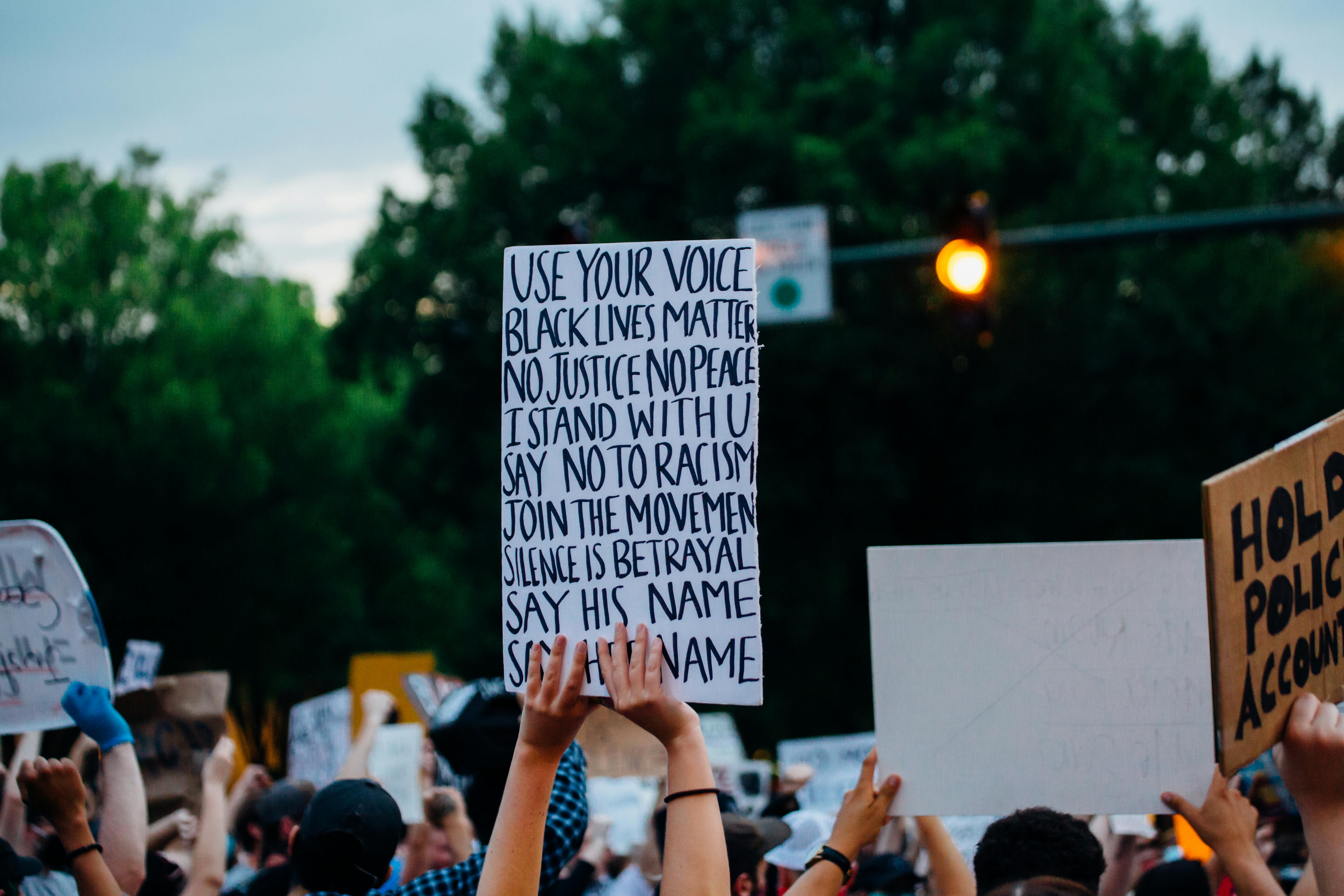 Crop people protesting against racism on street · Free Stock Photo