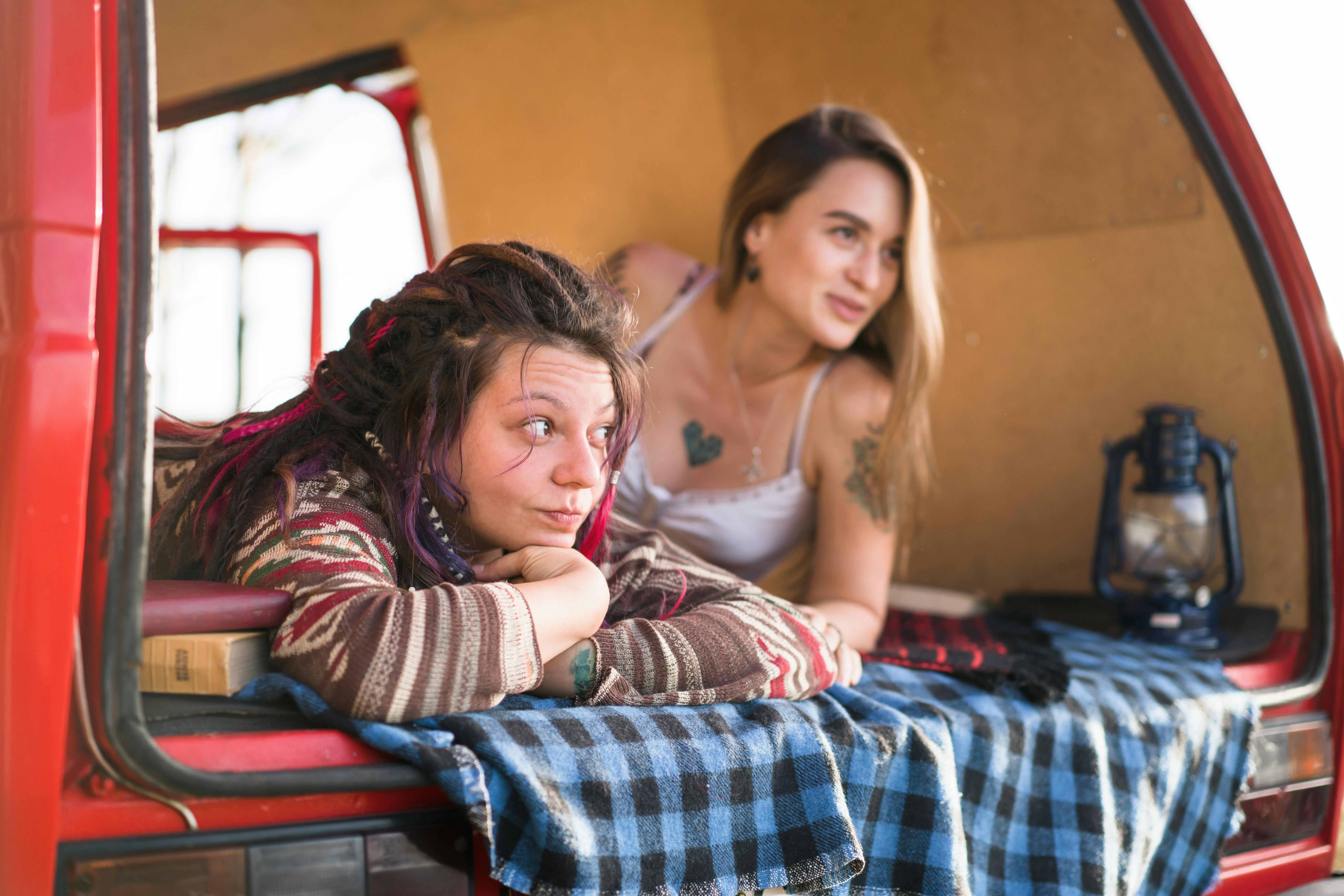 Travelers standing on vans in remote valley · Free Stock Photo