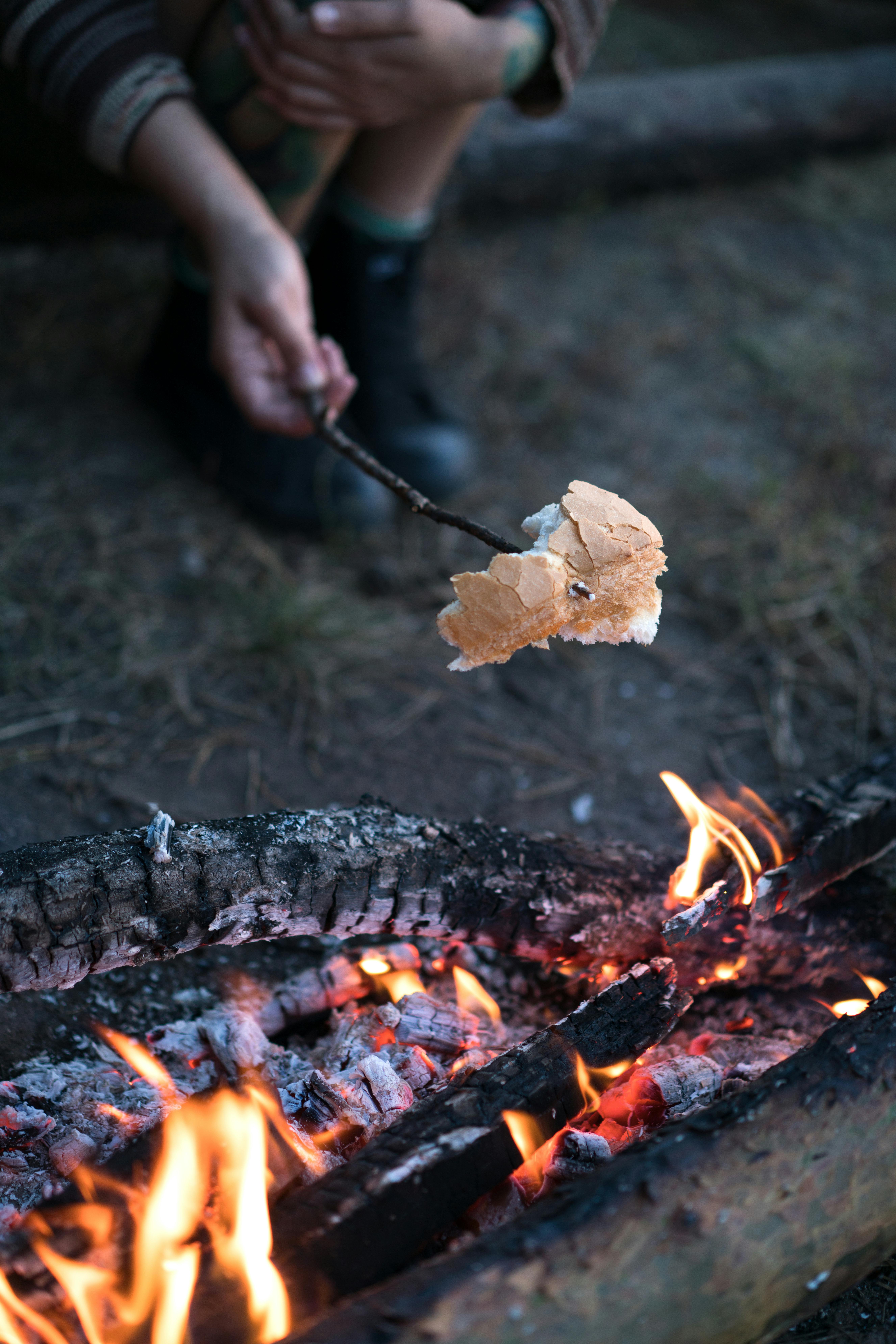 Person Cooking Food over Fire · Free Stock Photo