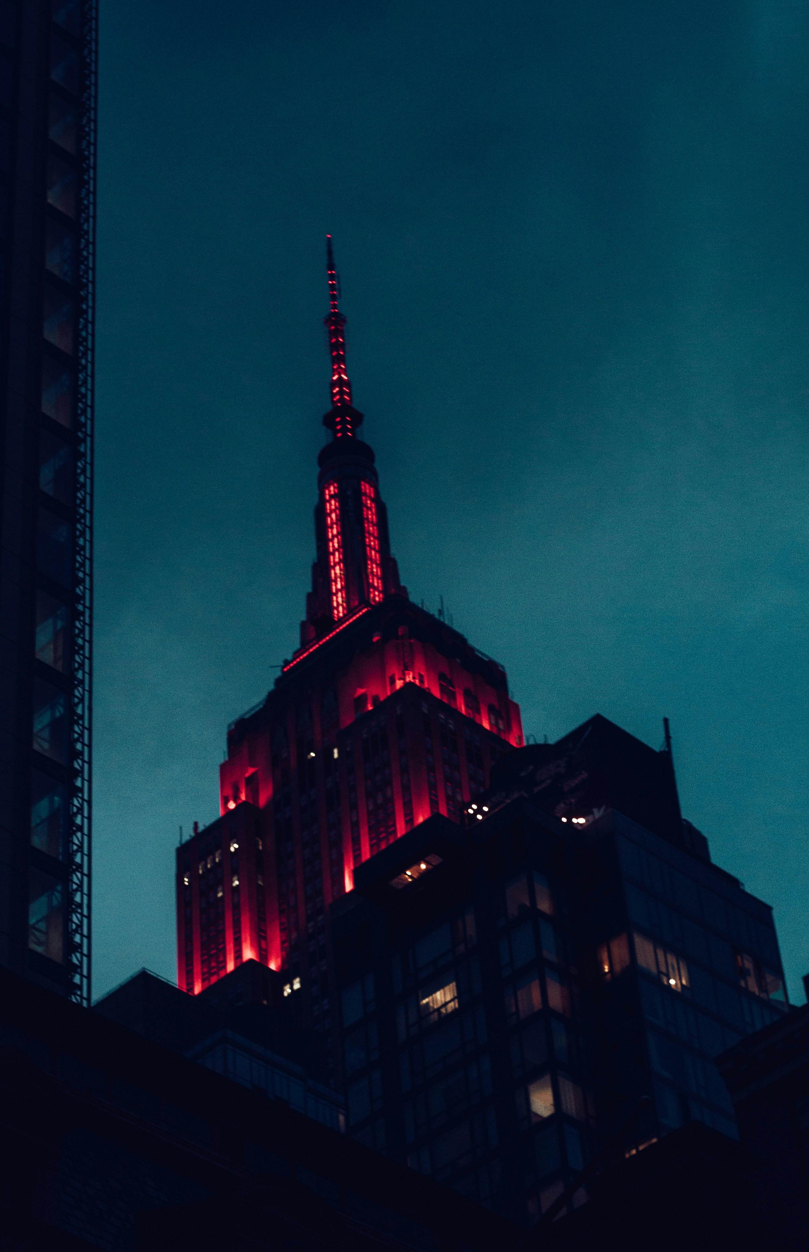 Illuminated skyscraper against blue evening sky · Free Stock Photo