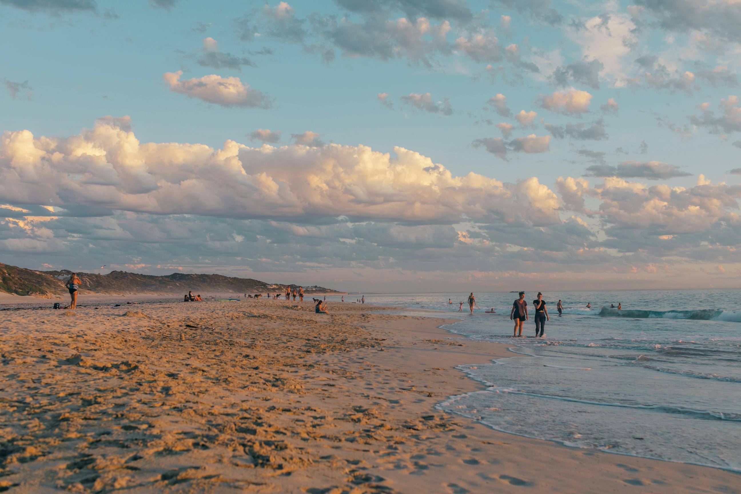 Unrecognizable tourists walking along sandy beach and waving sea · Free ...