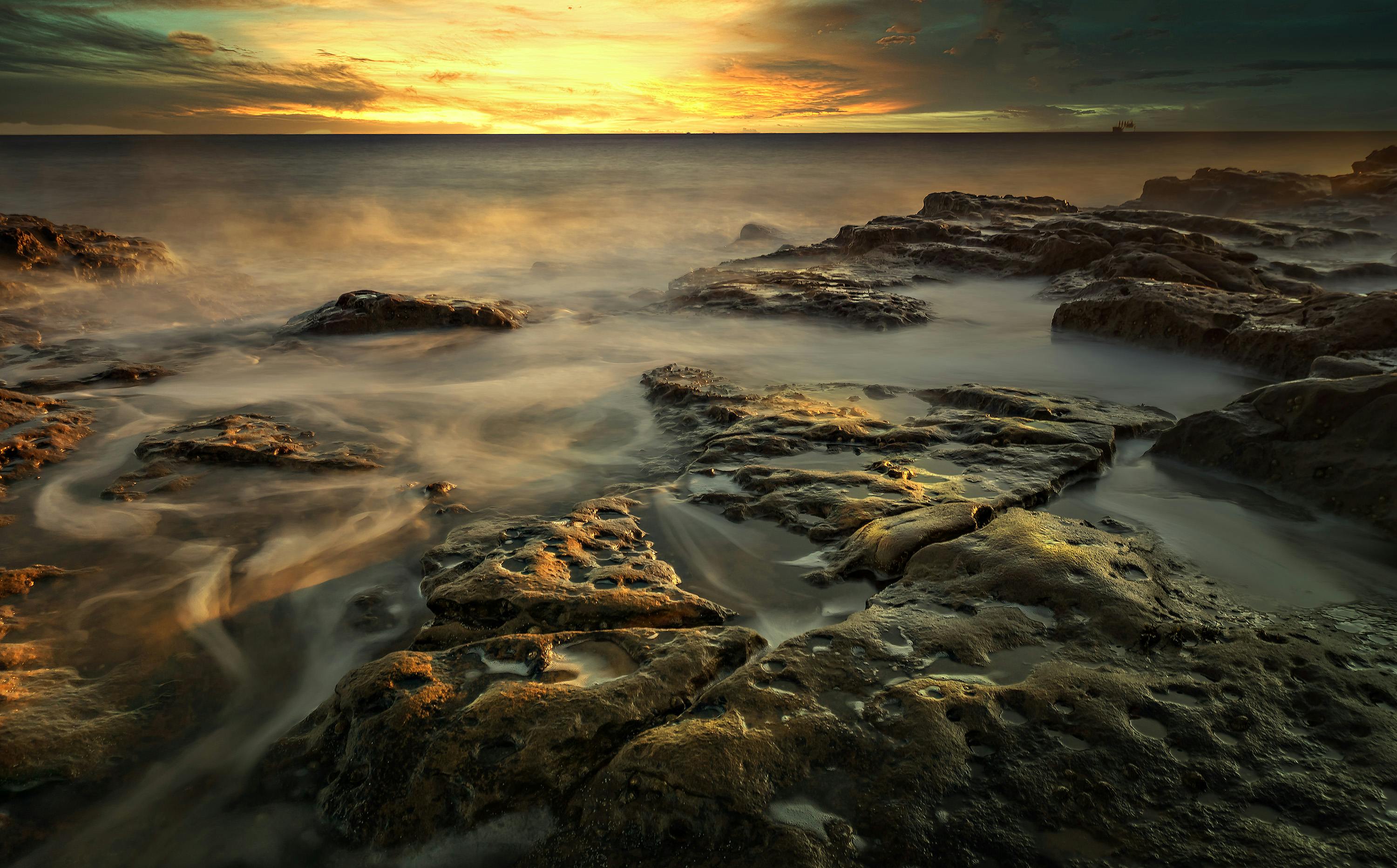 Sea water stream near rocks in fog at sunset · Free Stock Photo