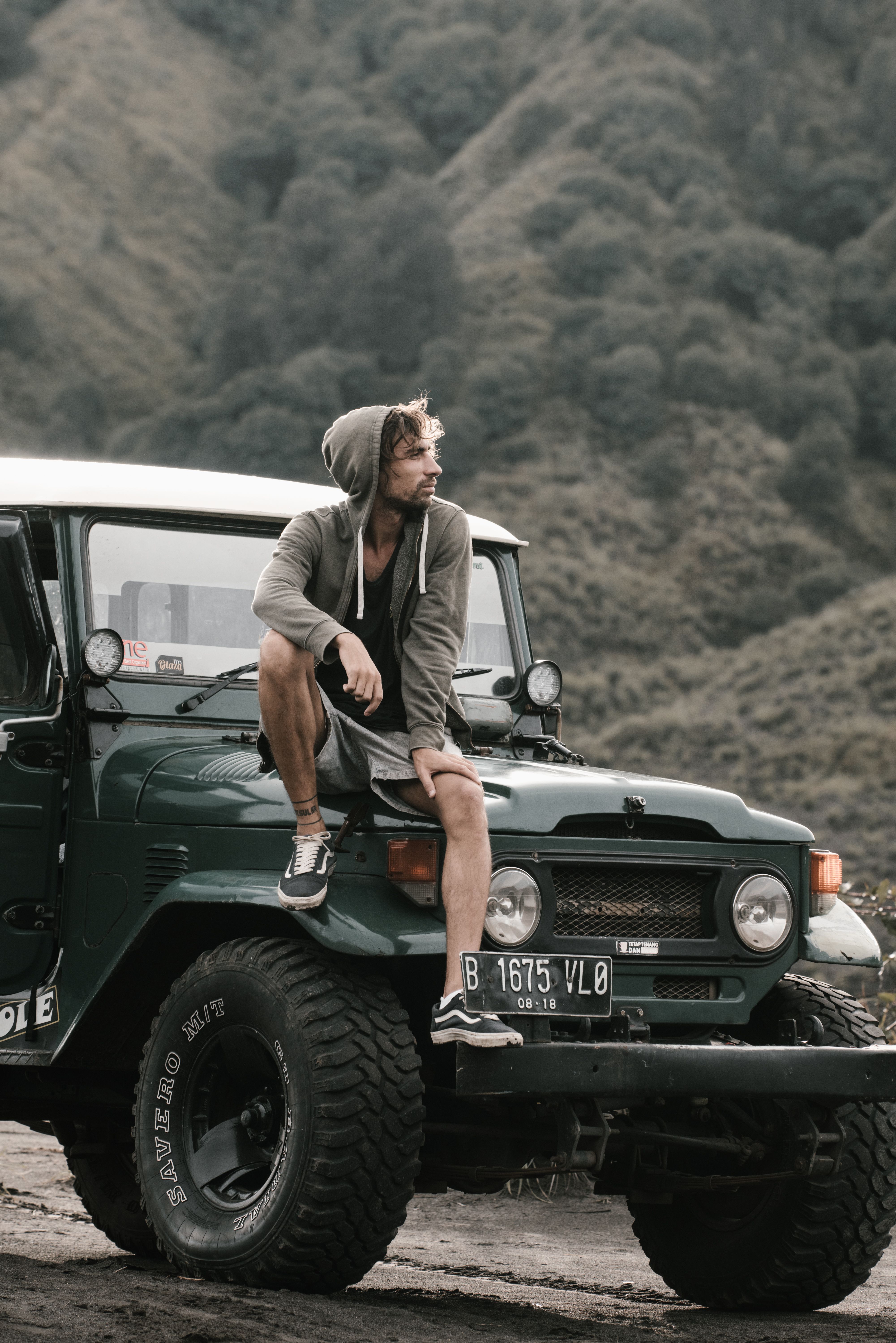 Man Sitting on Jeep · Free Stock Photo