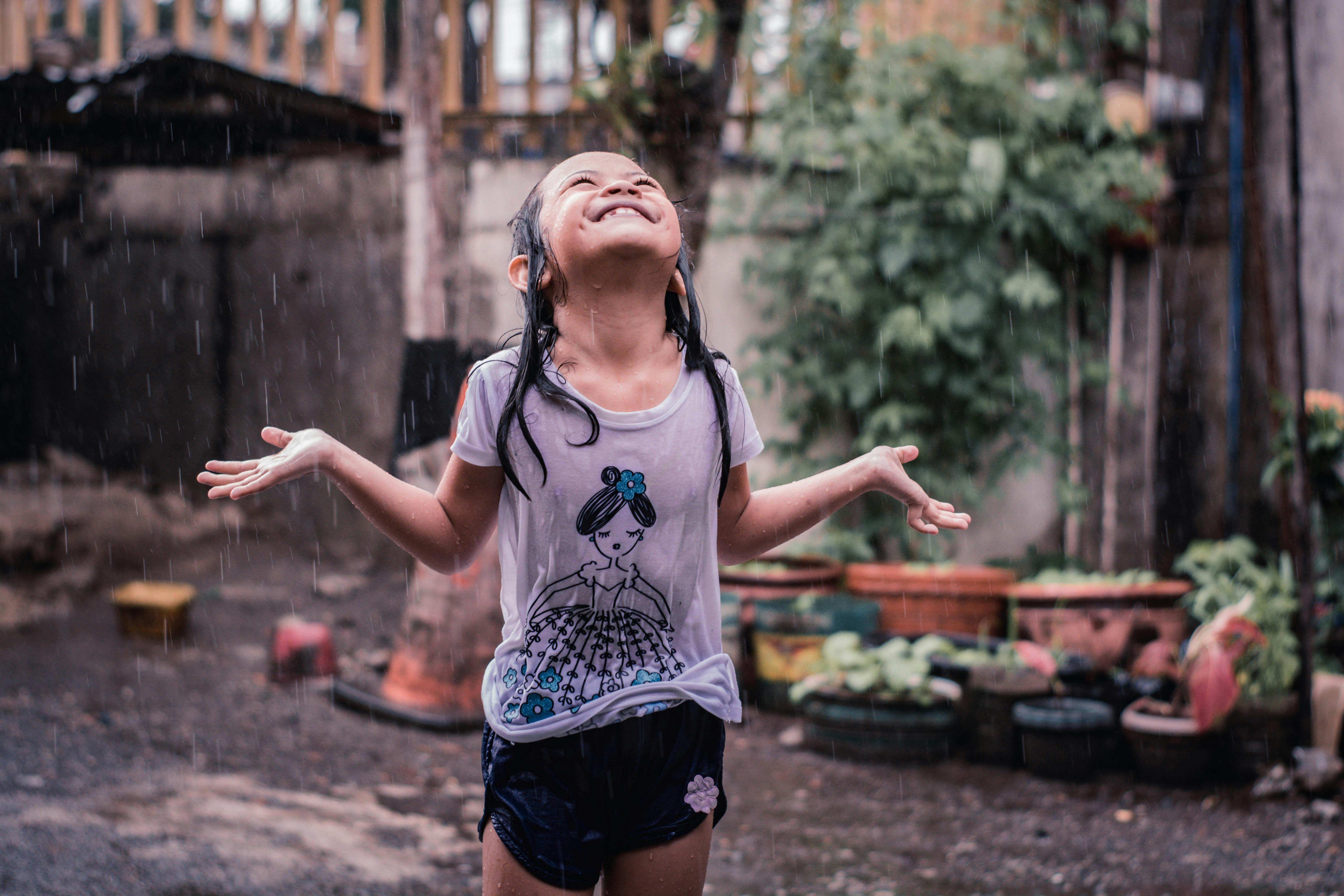 Little Girl Playing in the Rain · Free Stock Photo