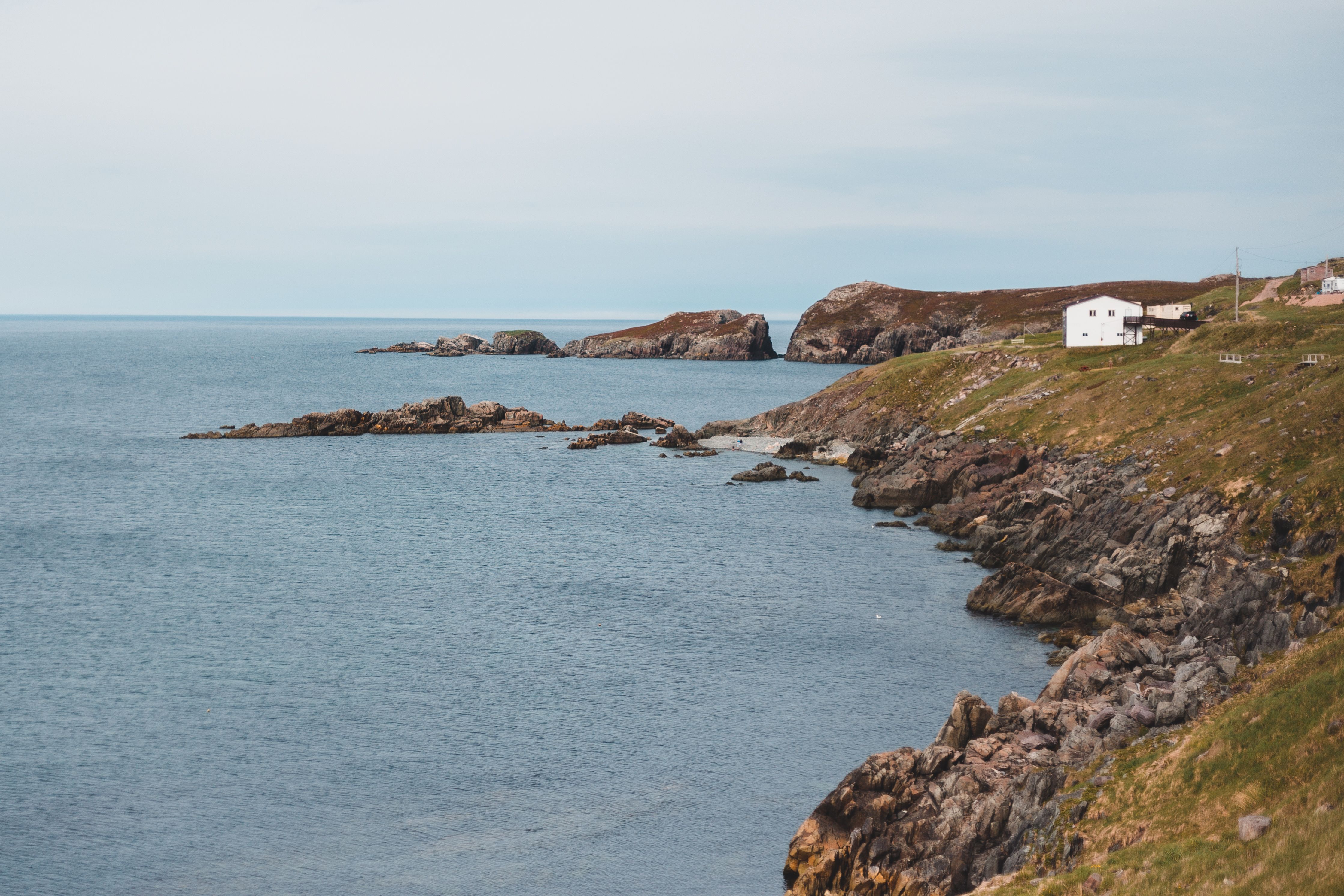 Lonesome house on rocky coastline near sea · Free Stock Photo