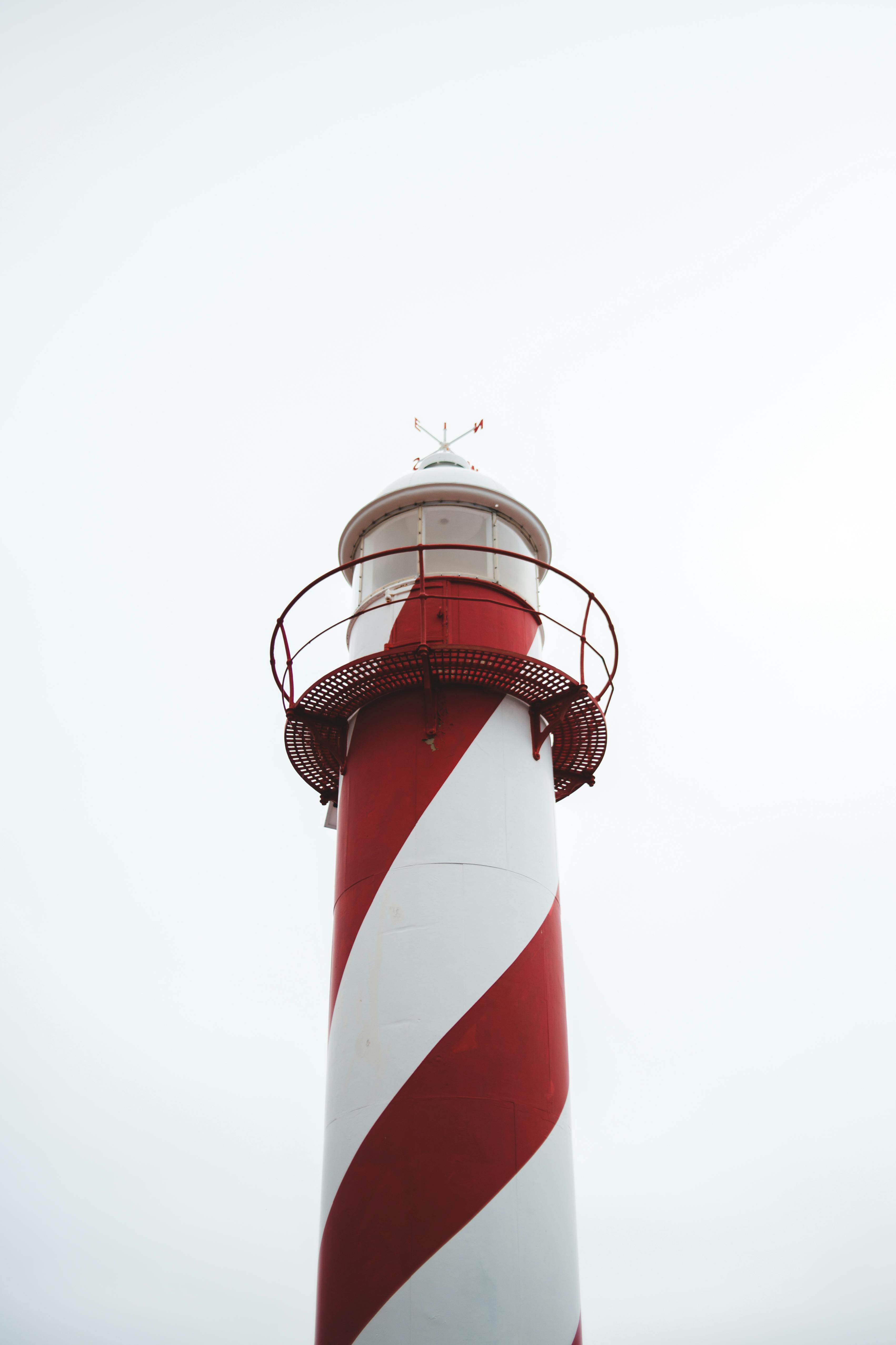 Tall lighthouse tower against gray sky · Free Stock Photo