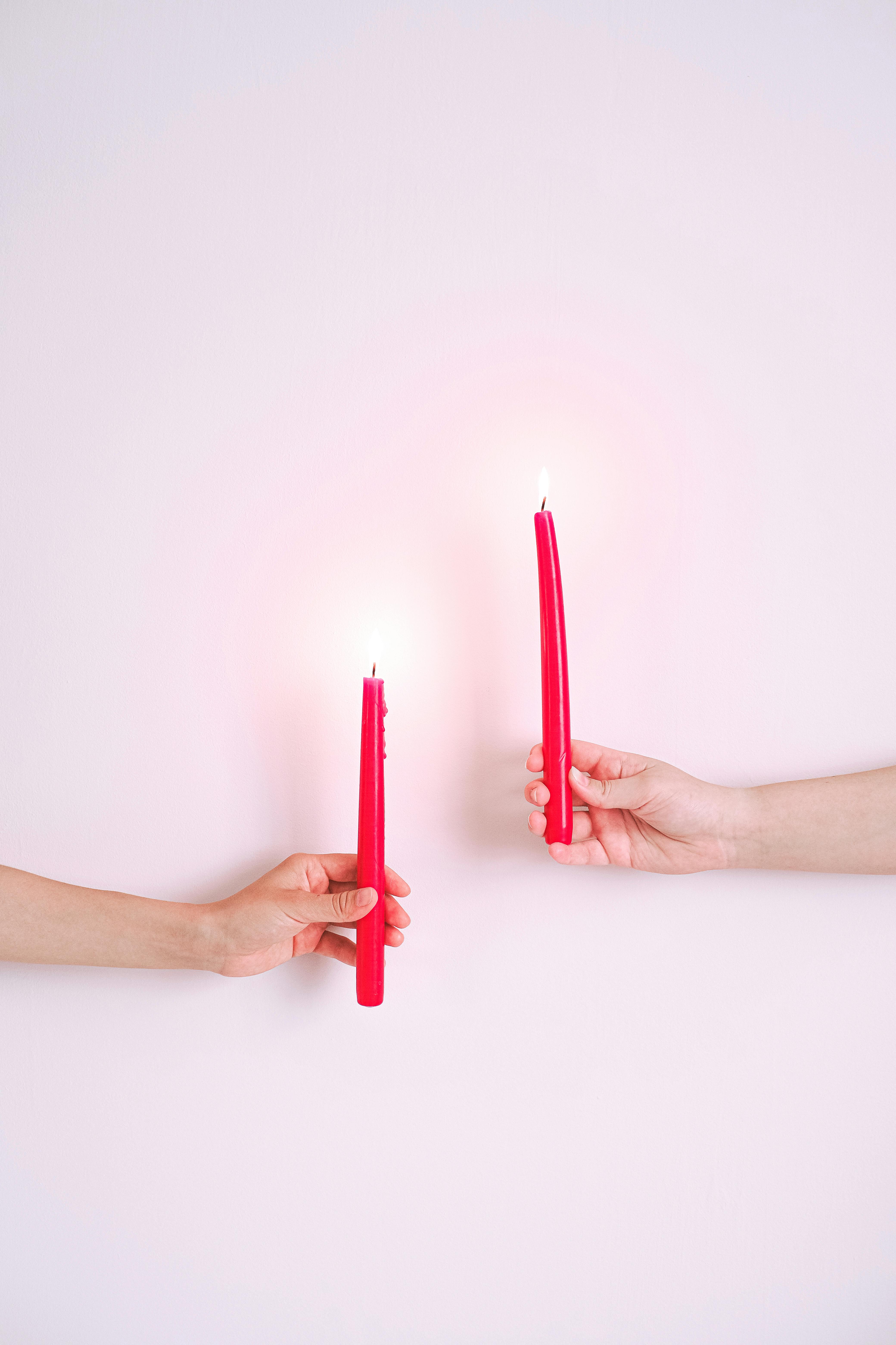 People Holding Red Candles with White Background · Free Stock Photo