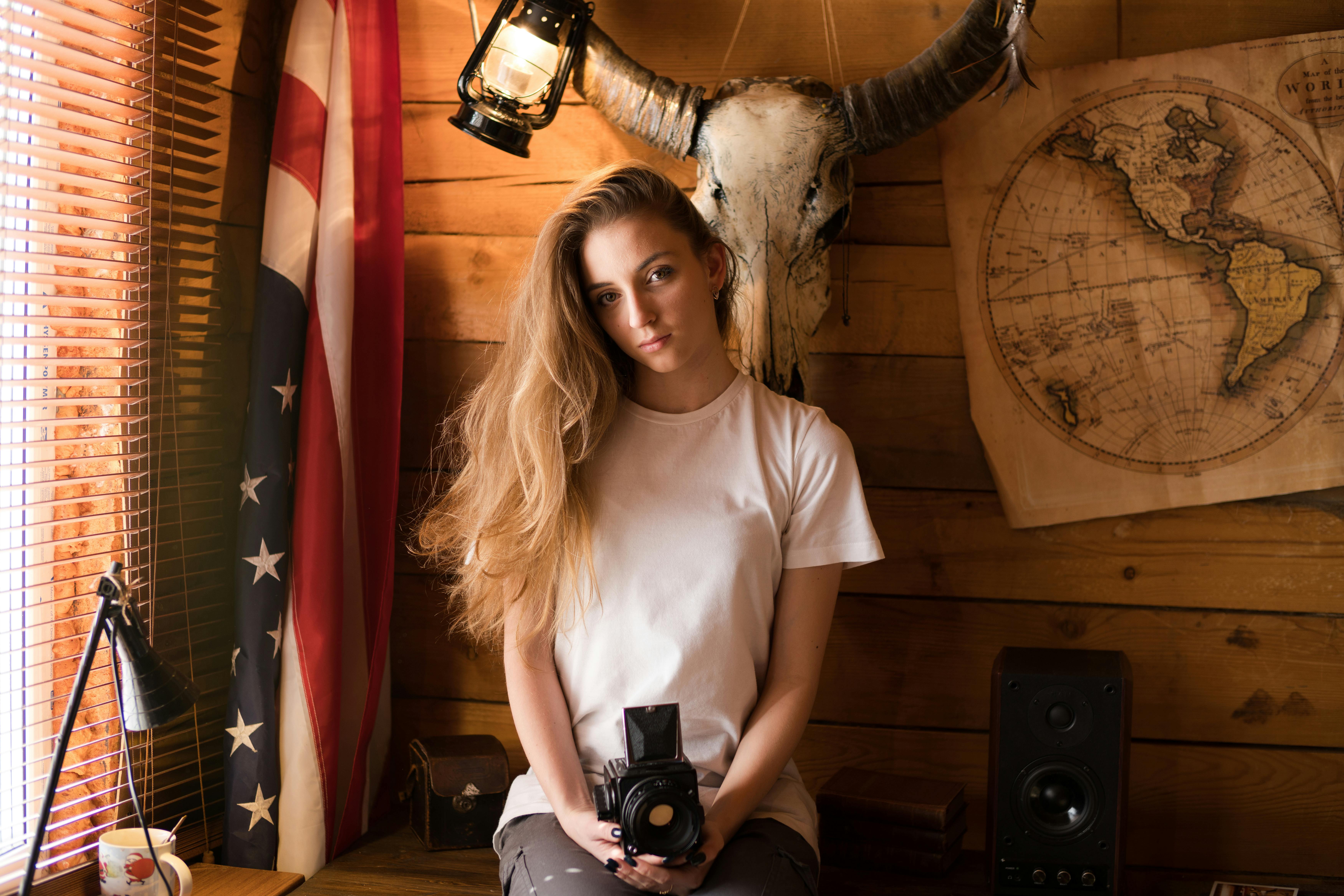 Woman Sitting and Holding Camera · Free Stock Photo