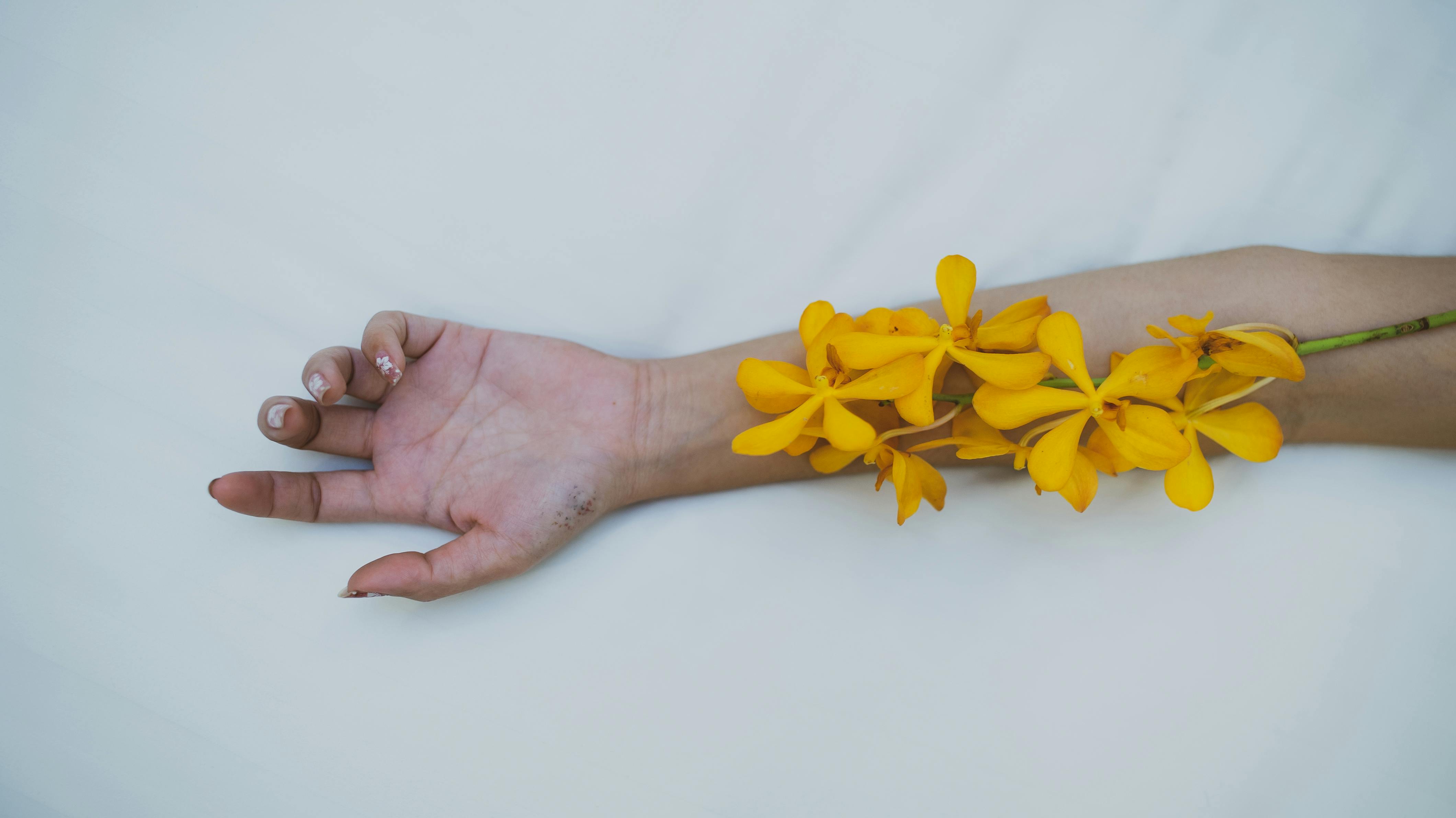 Yellow Flowers on Person's Arm · Free Stock Photo