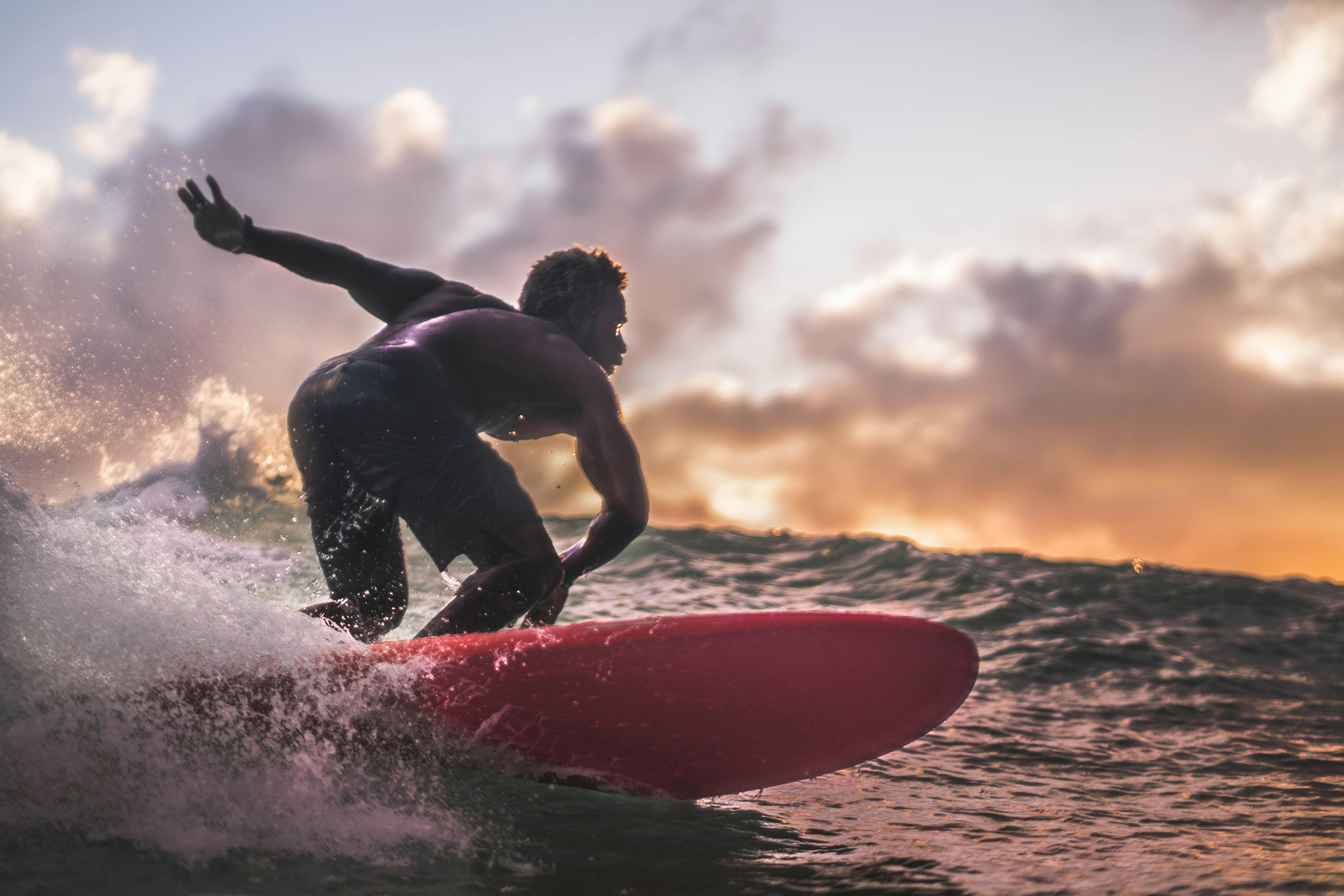 Man Surfing at Sunset · Free Stock Photo