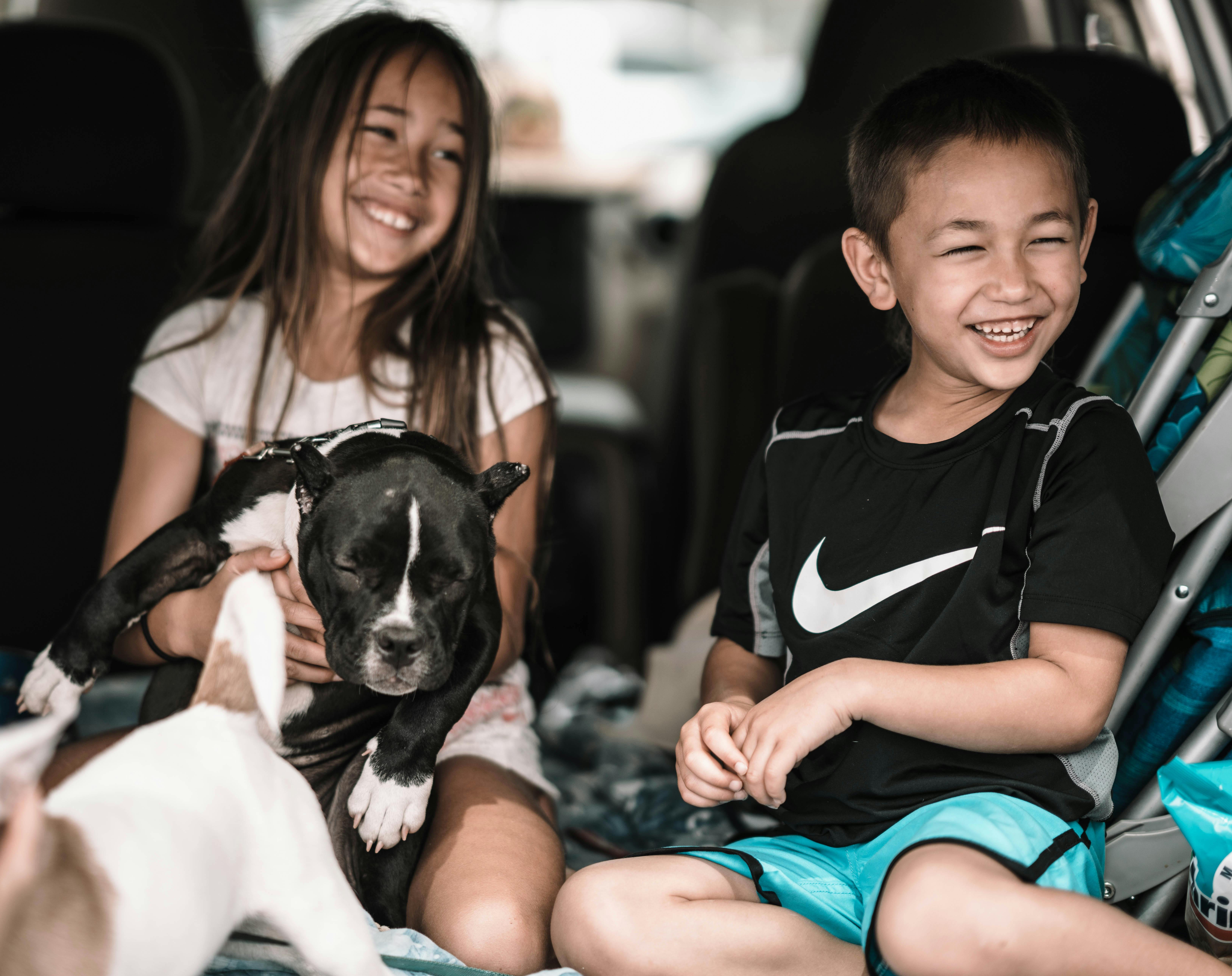 Smiling Kids with their Dog · Free Stock Photo