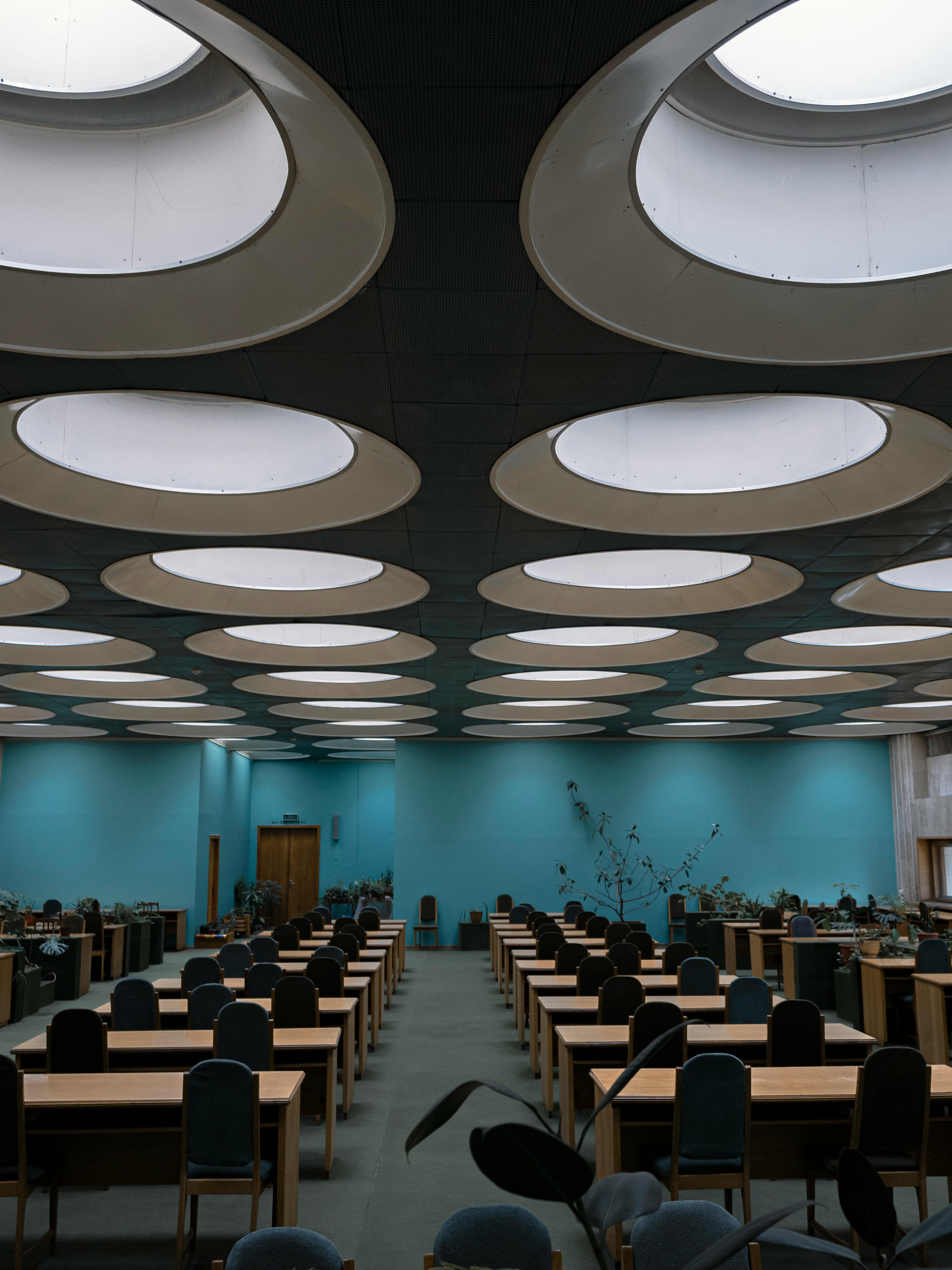 Interior of stylish room with round lamps on ceiling in library · Free ...