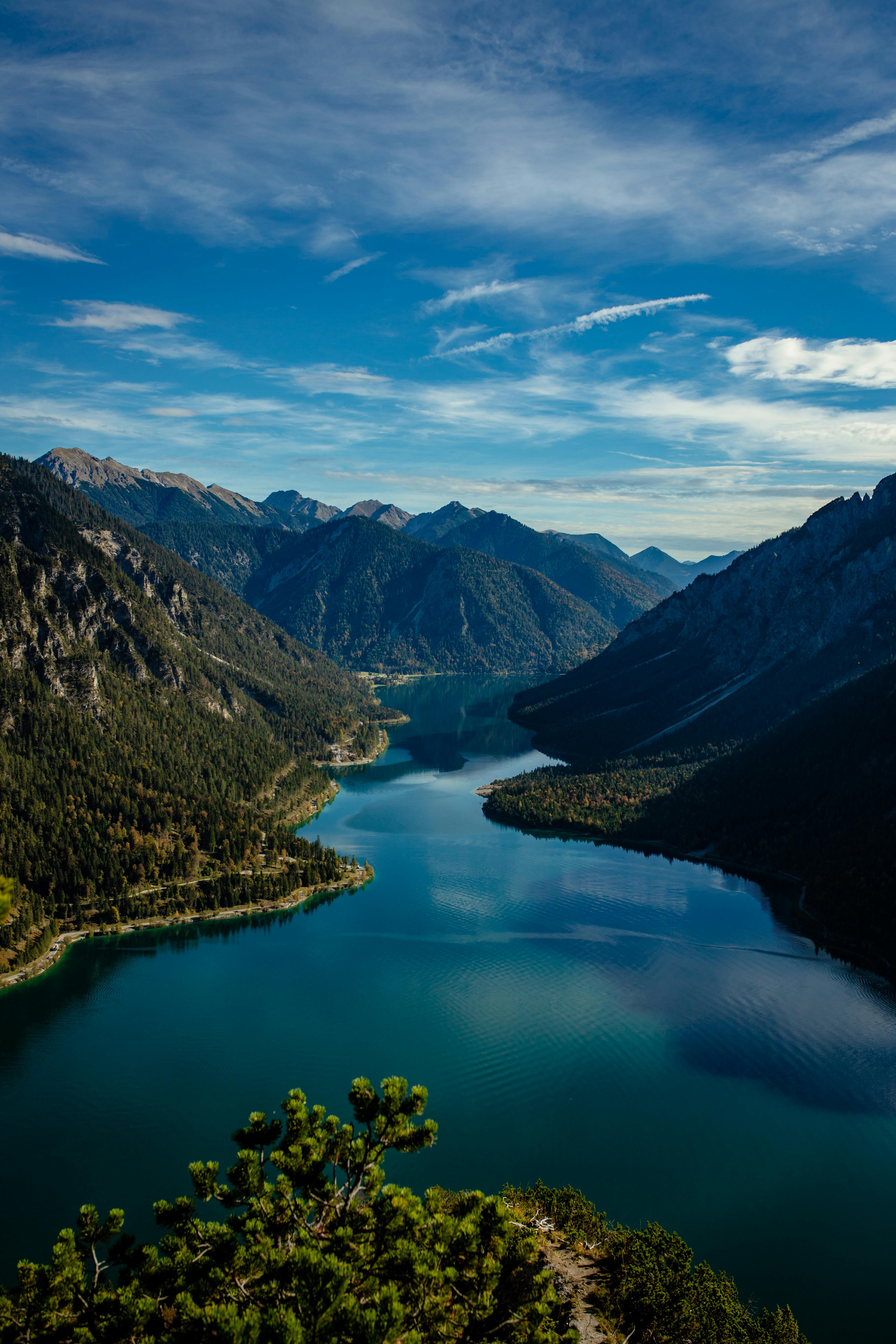 Man by the River in a Mountain Valley · Free Stock Photo