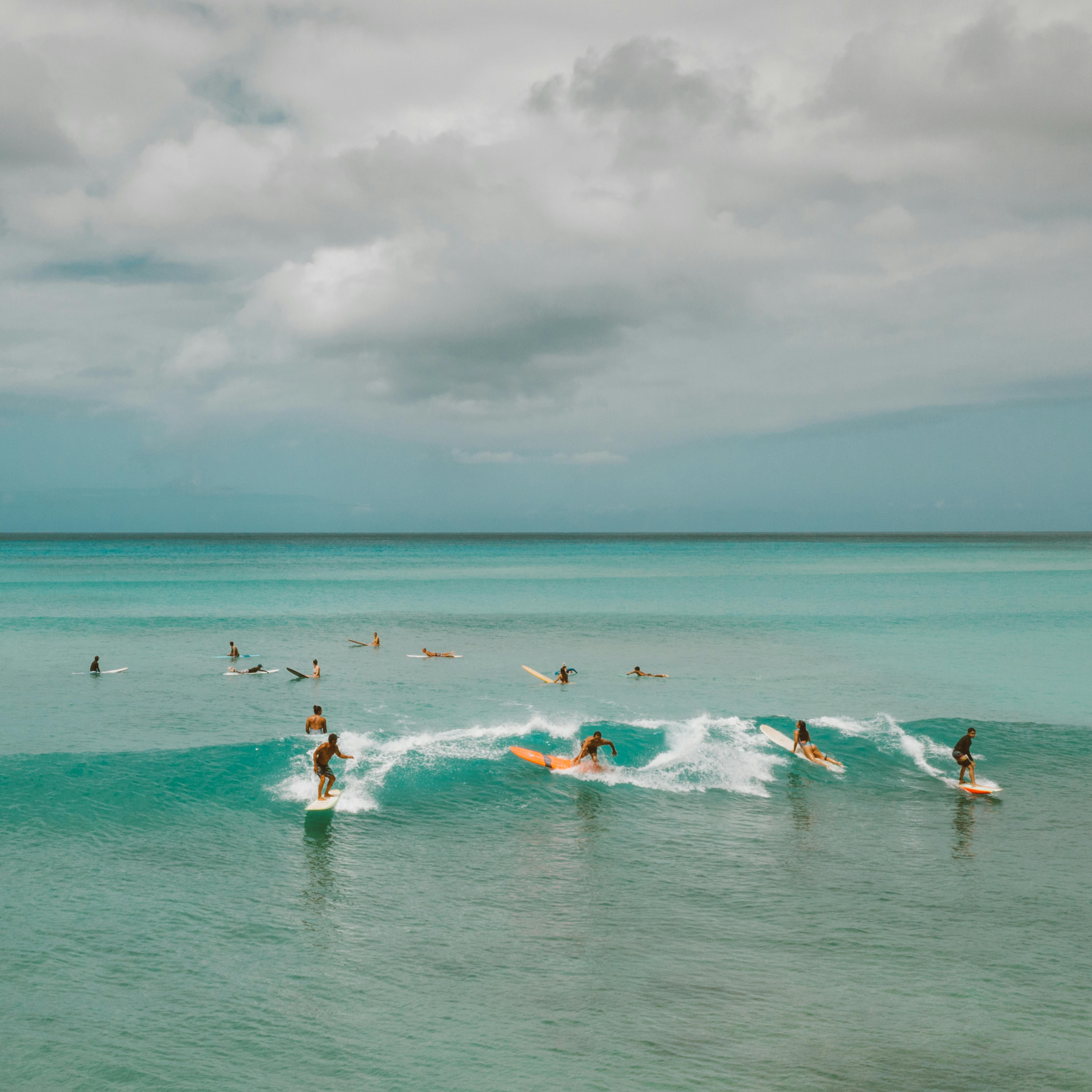 People Surfing on Sea Waves · Free Stock Photo