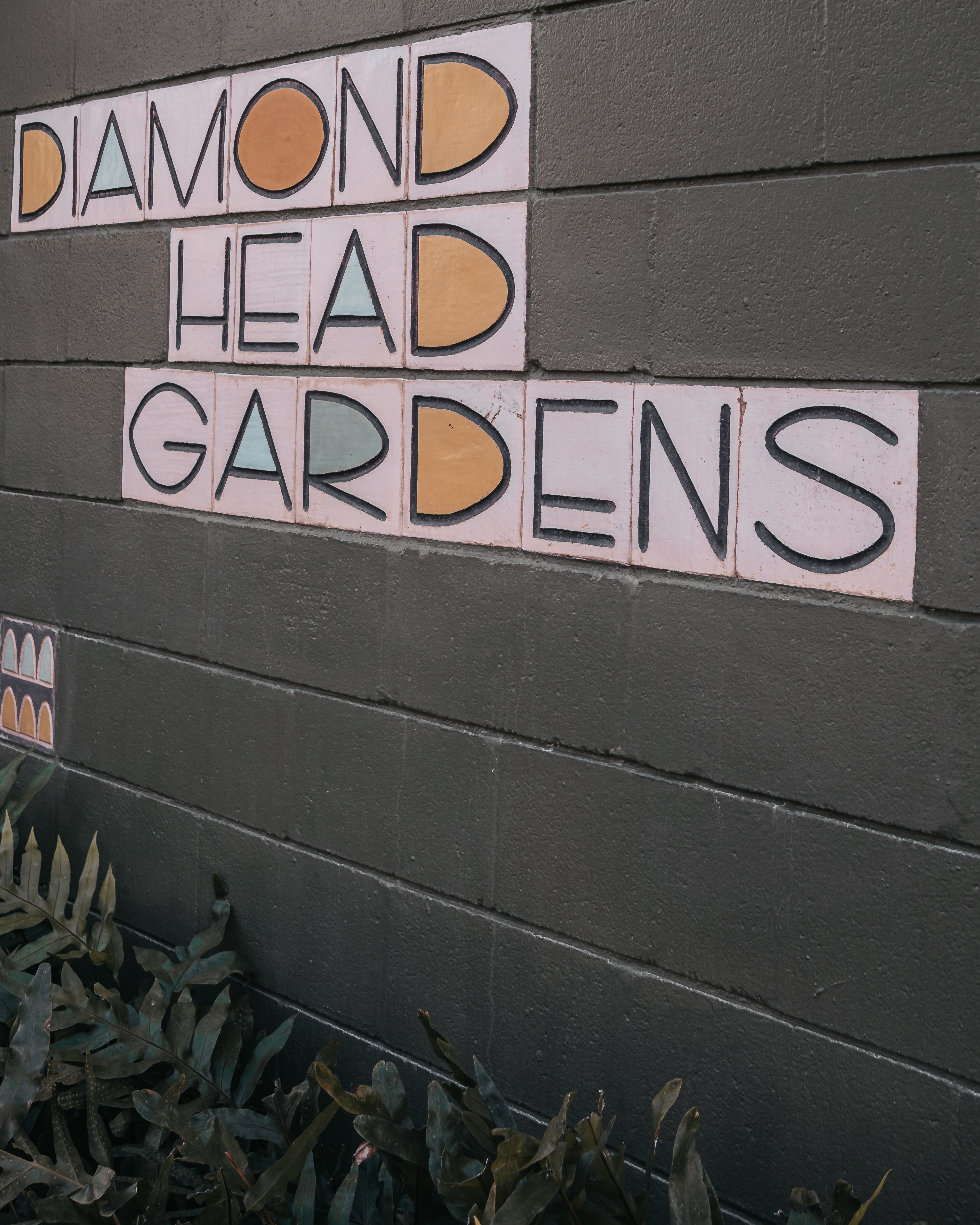 Diamond Head Gardens Text on Gray Wall · Free Stock Photo