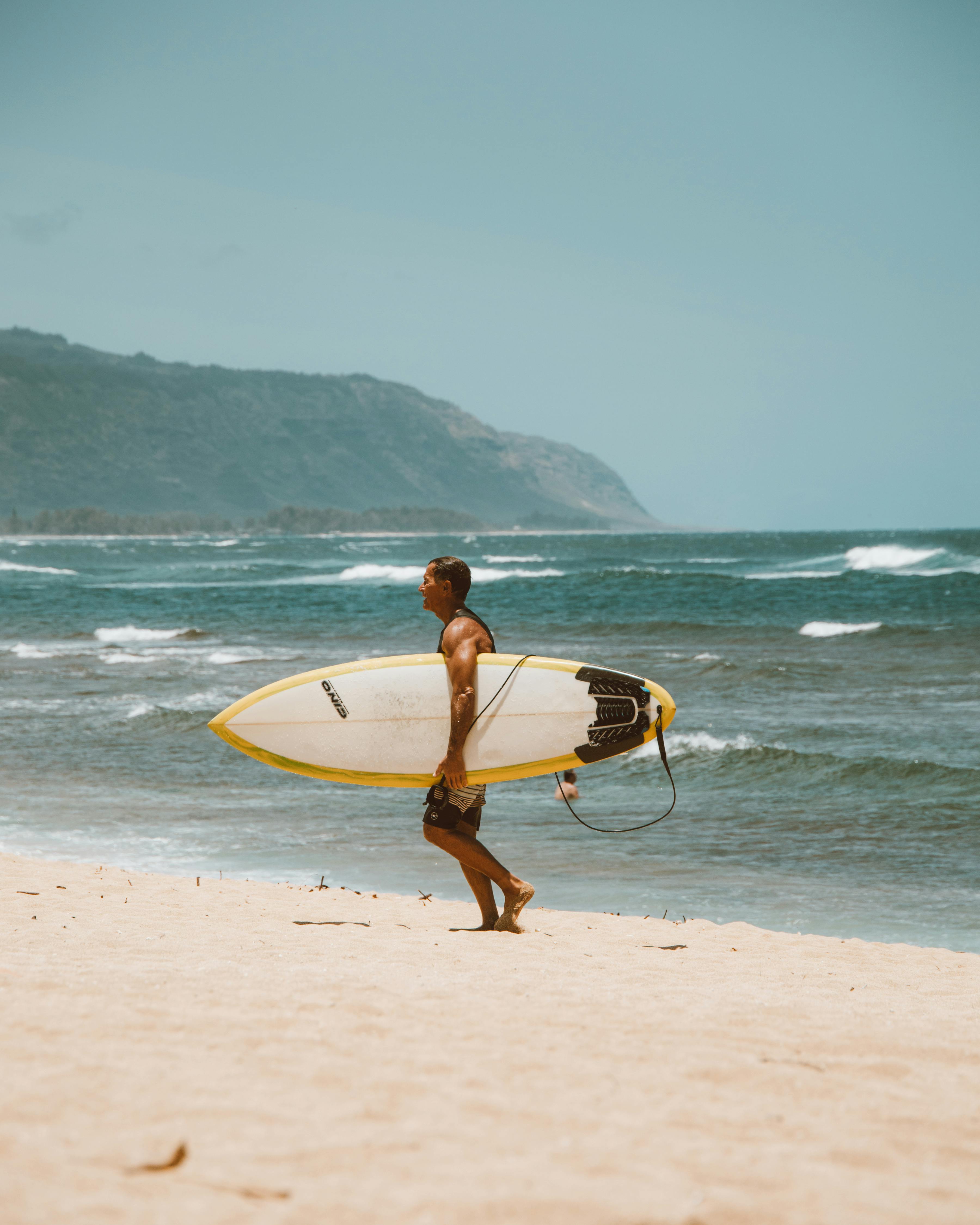 A Man Surfing at the Beach · Free Stock Photo