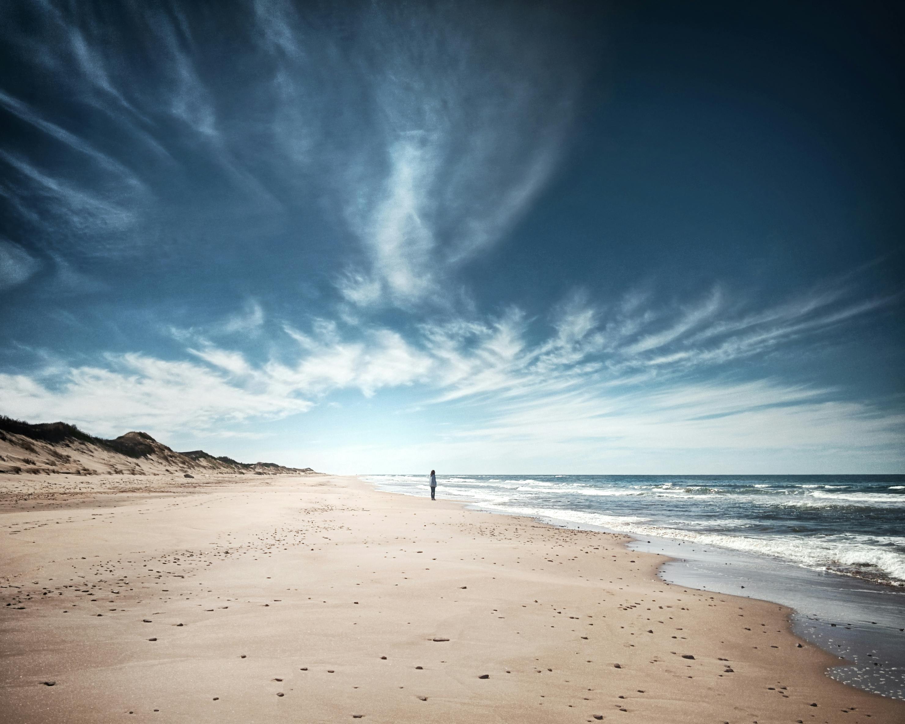 Distant person on sandy beach enjoying magnificent ocean view · Free ...