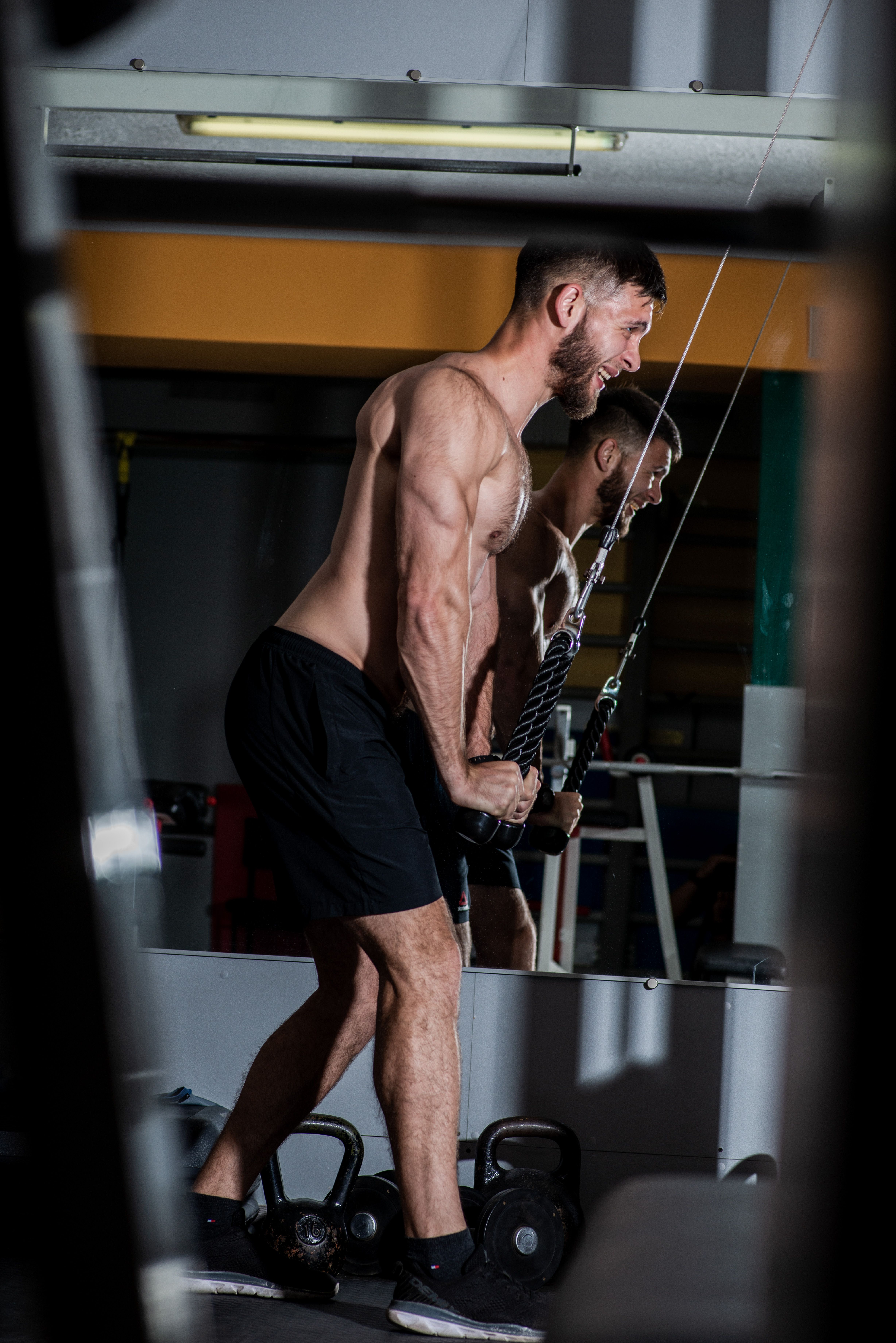 Shirtless black man fighting with ropes in studio · Free Stock Photo