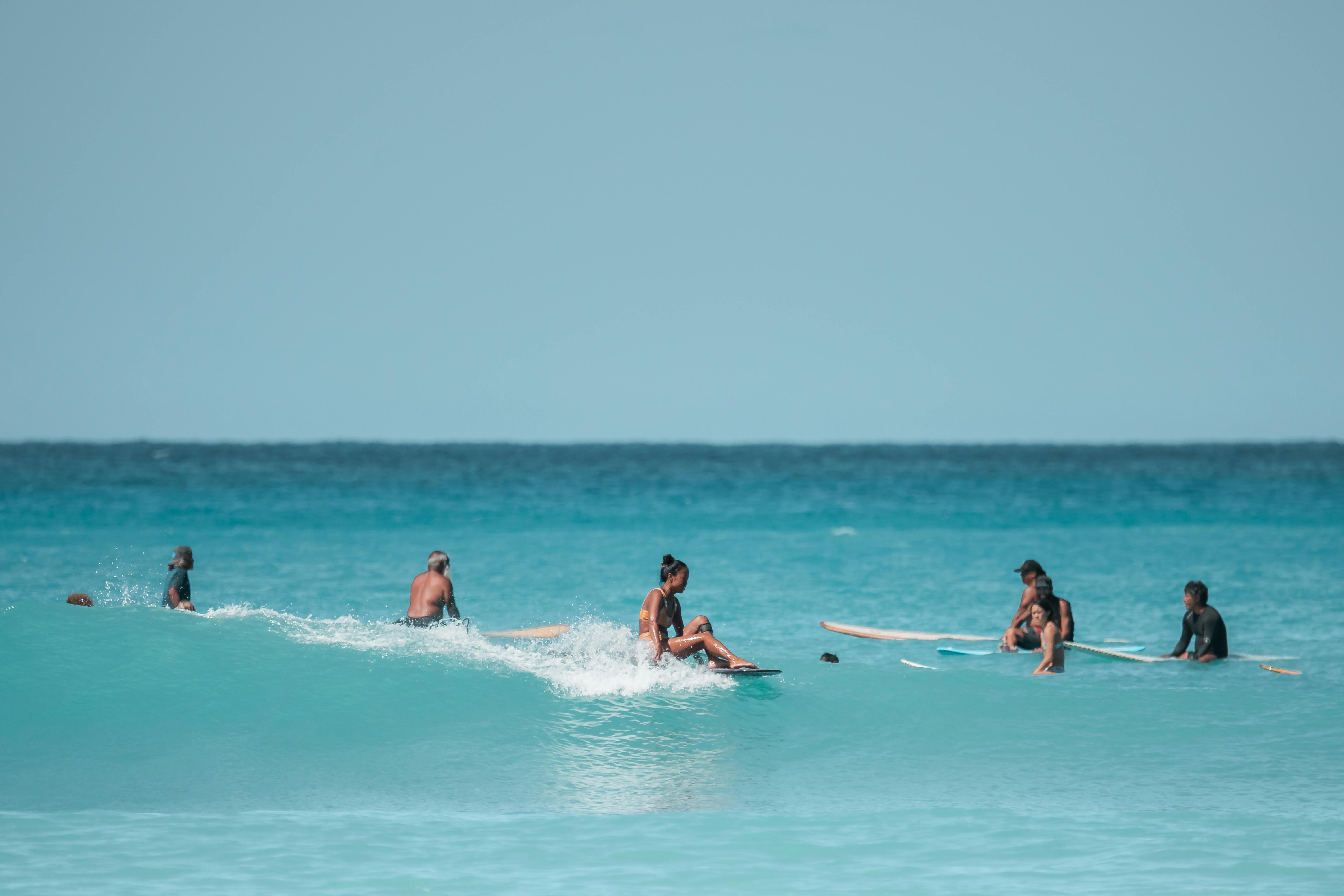 People Surfing on Sea Waves · Free Stock Photo