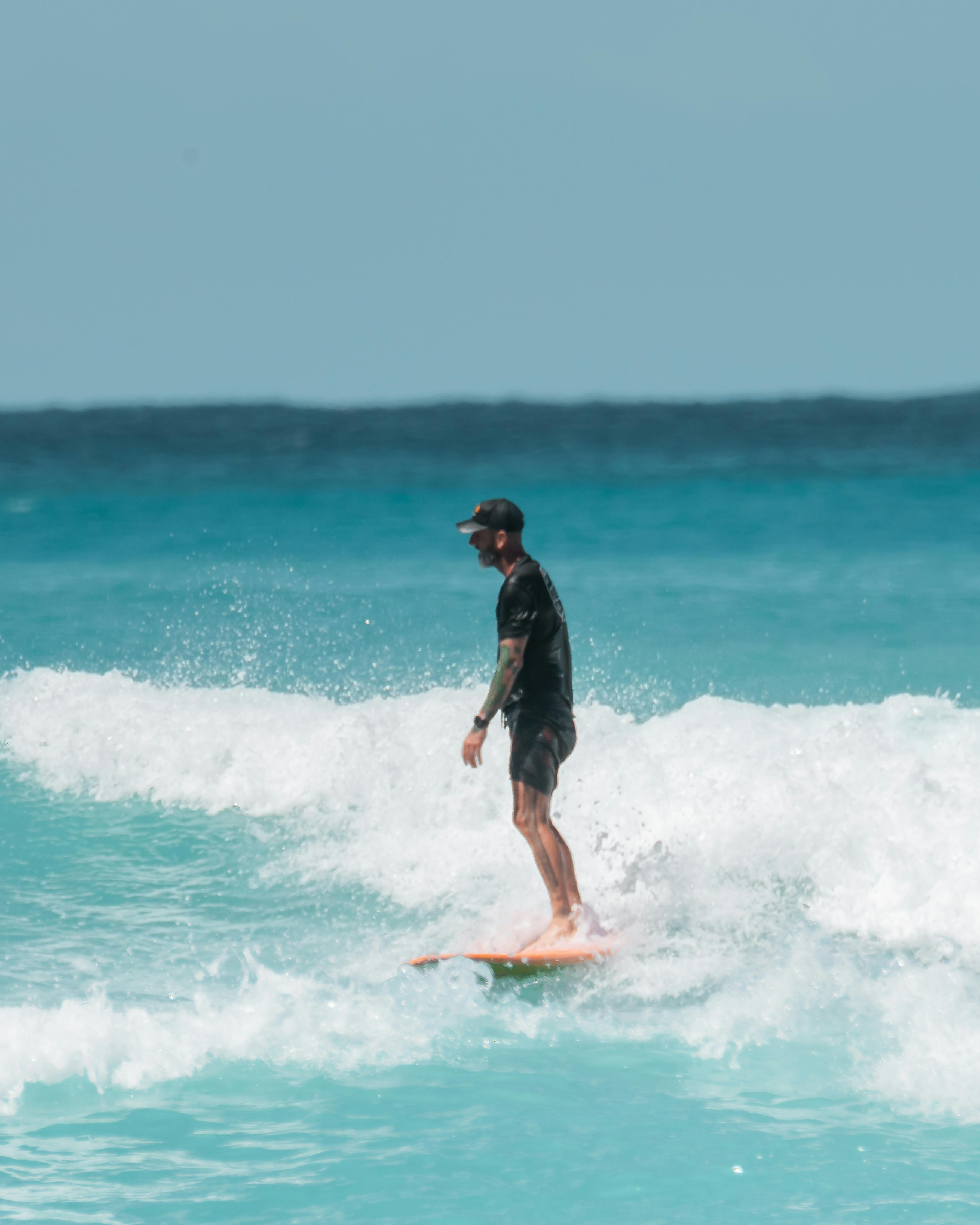Man in Black Wet Suit Surfing on Sea Waves · Free Stock Photo