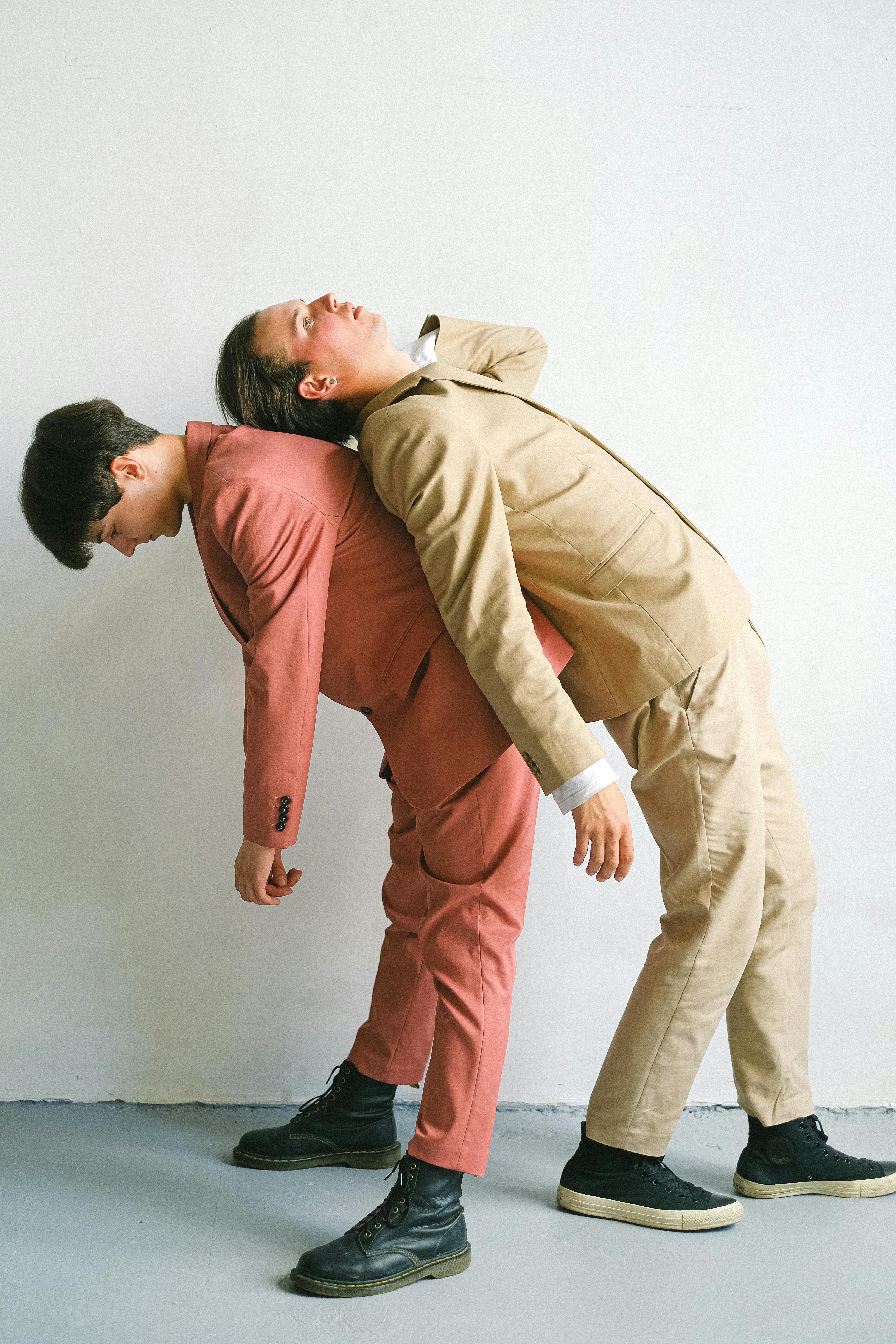 Man Making a Backbend Against Another Man · Free Stock Photo