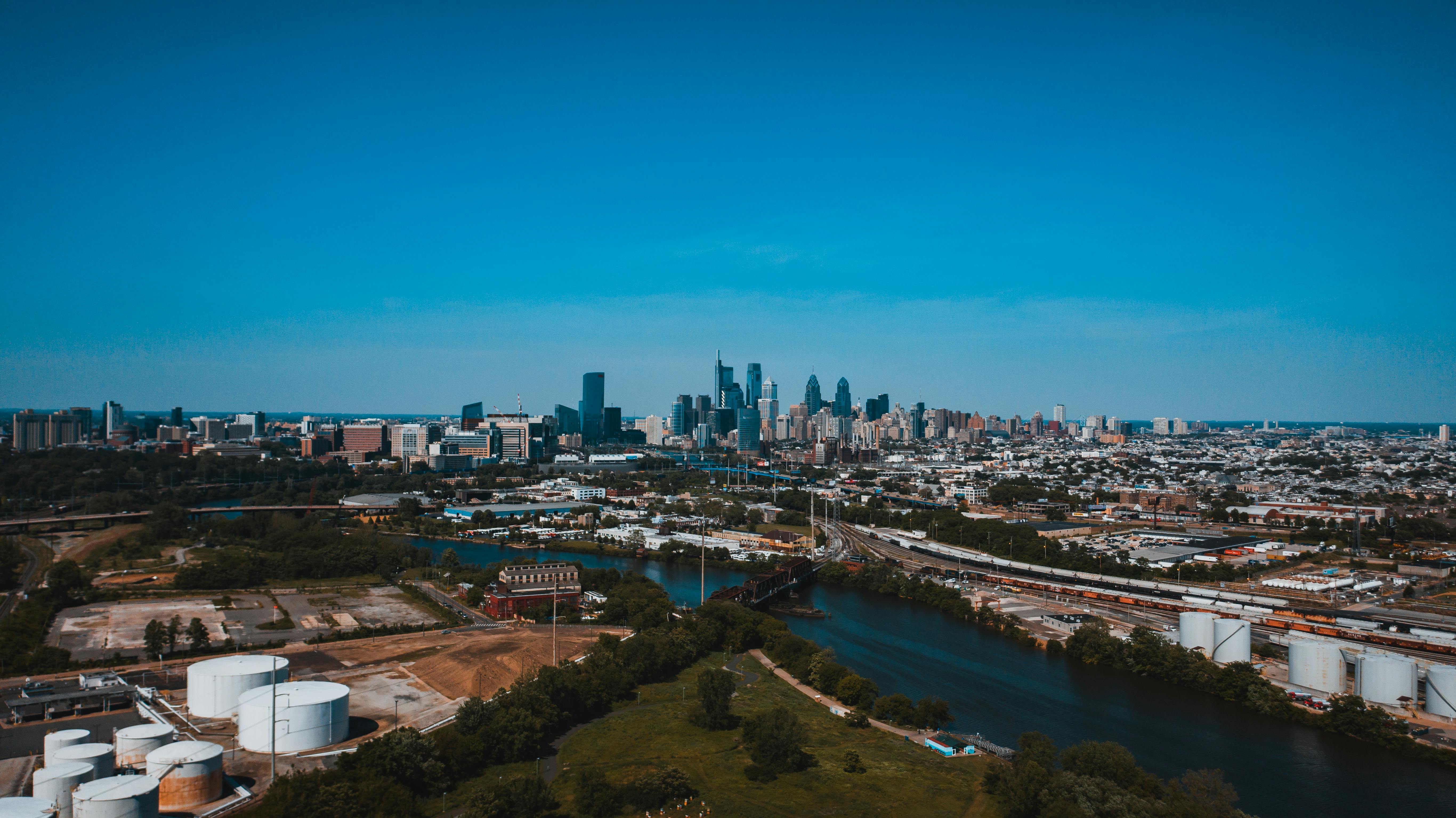Modern megapolis with skyscrapers under cloudy sky · Free Stock Photo