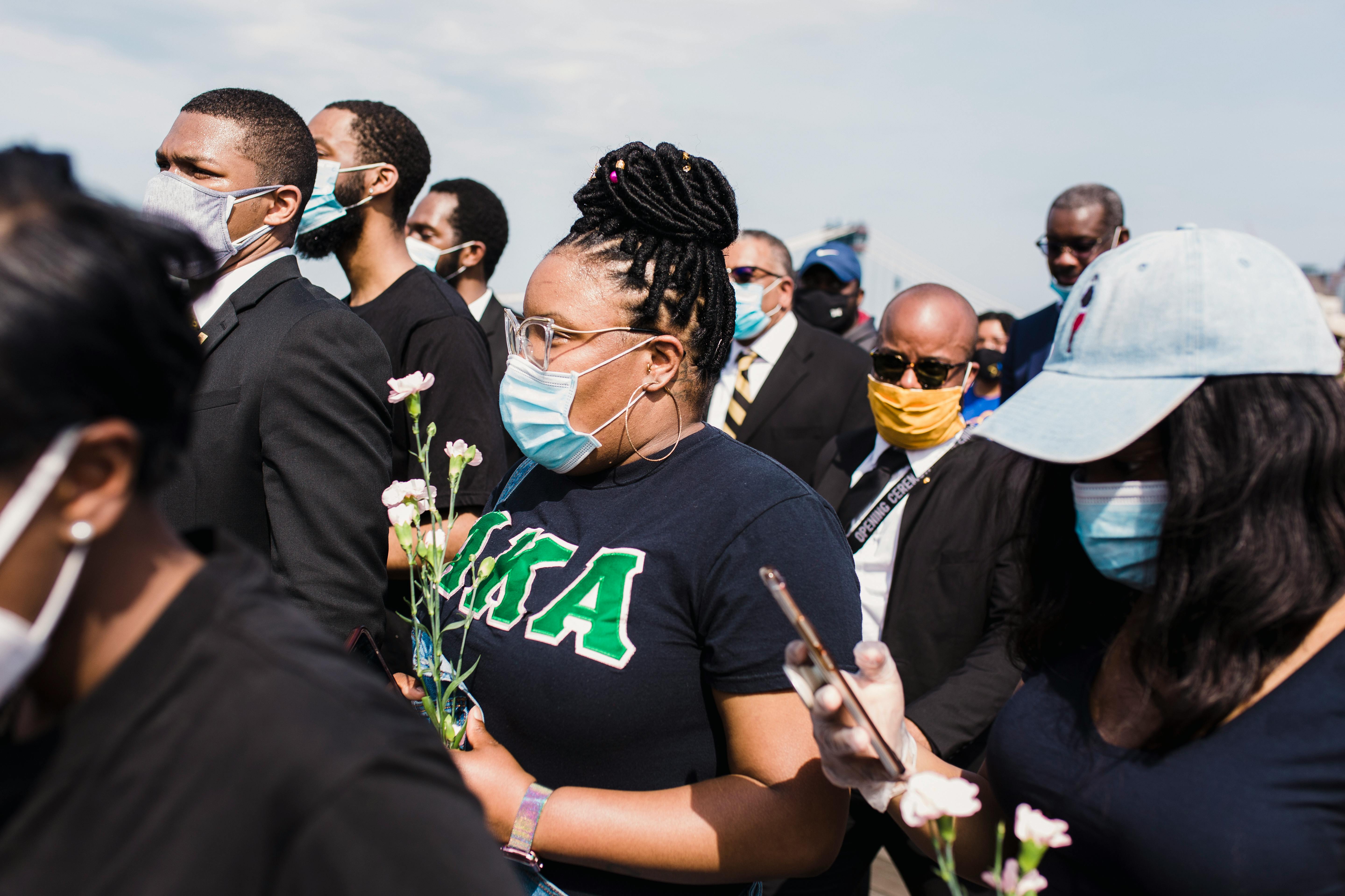 Woman at a Protest Holding Flowers · Free Stock Photo
