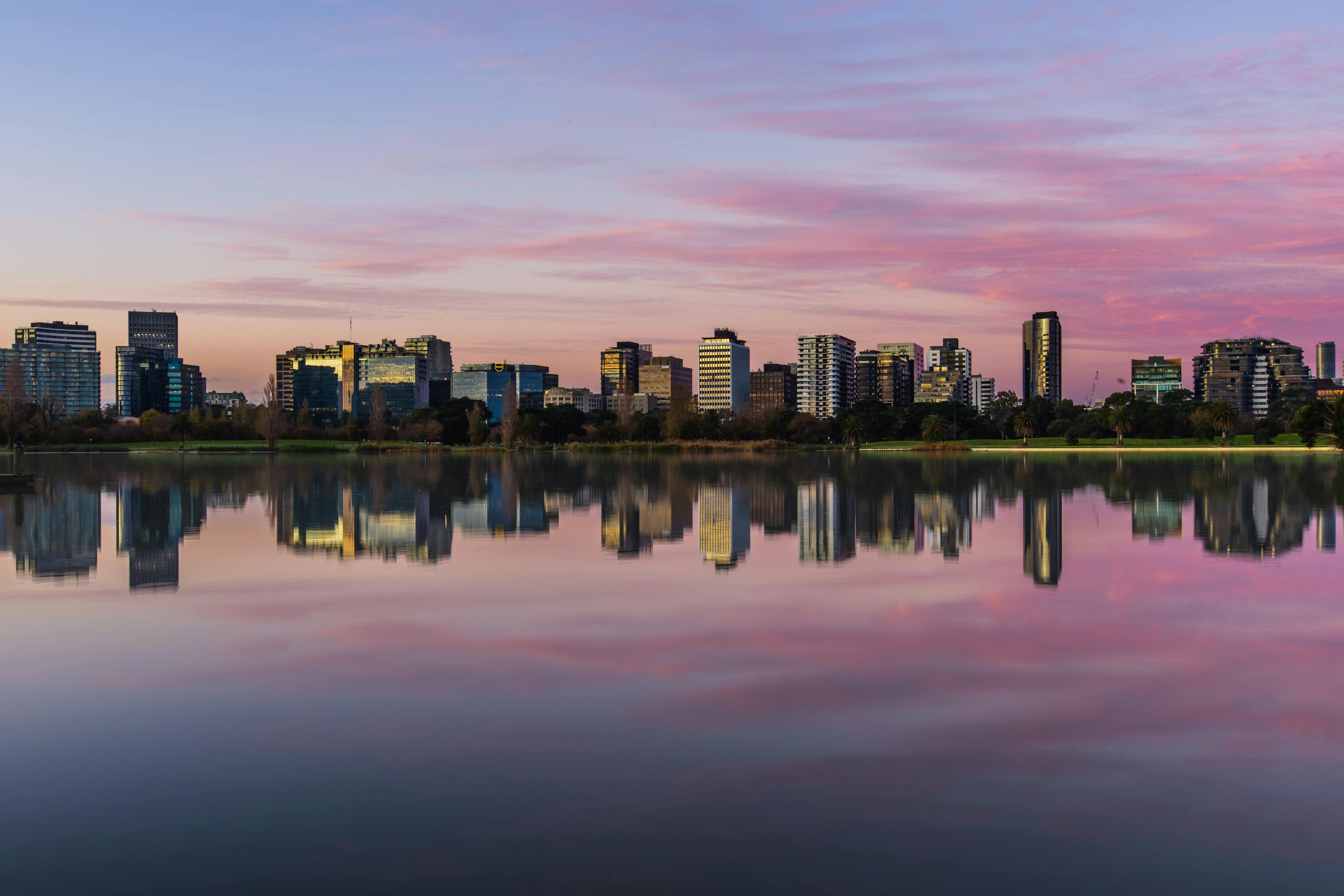 City Skyline Across Body of Water during Sunset · Free Stock Photo