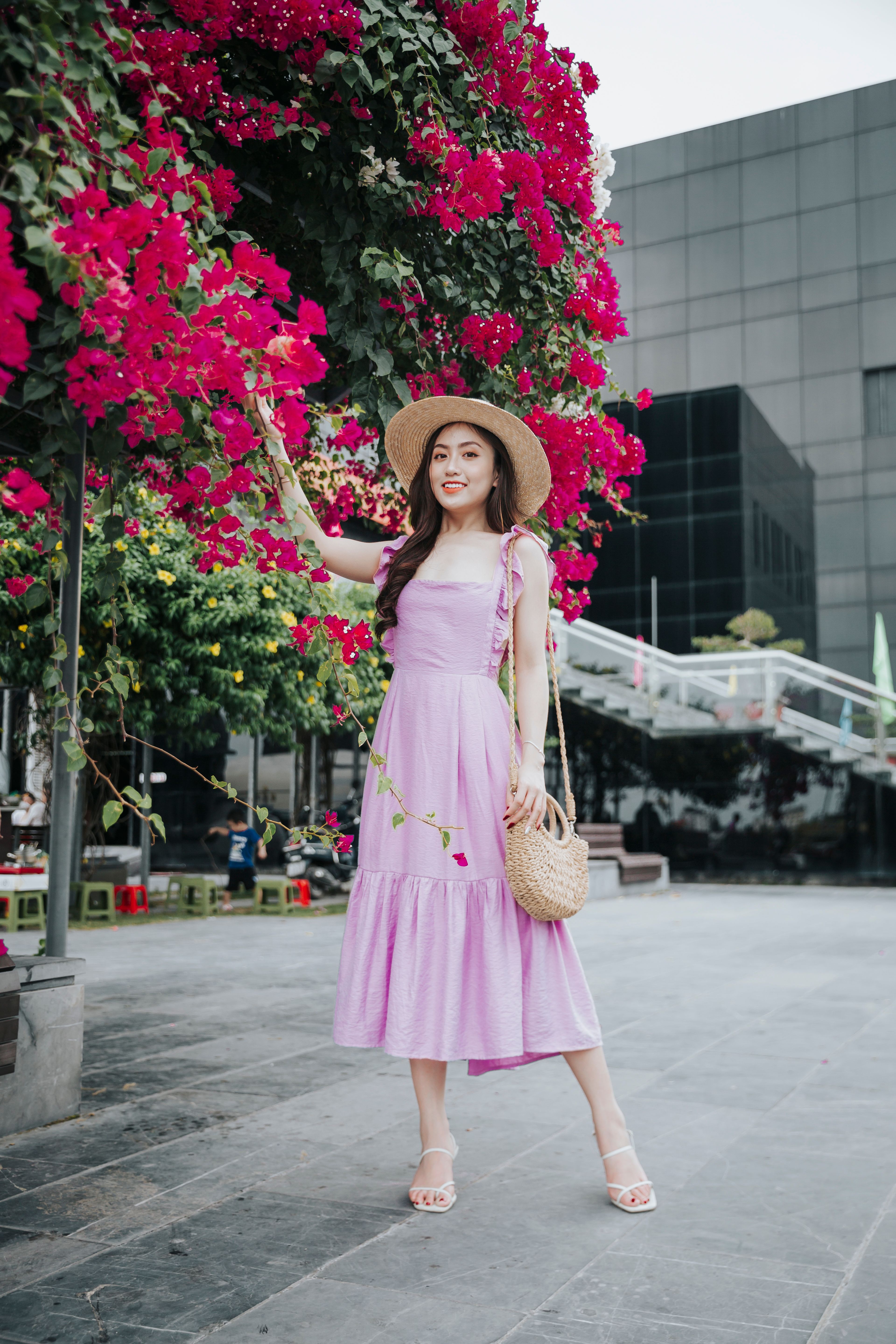 Smiling Stylish Asian Woman In Sundress On Pavement Free Stock Photo