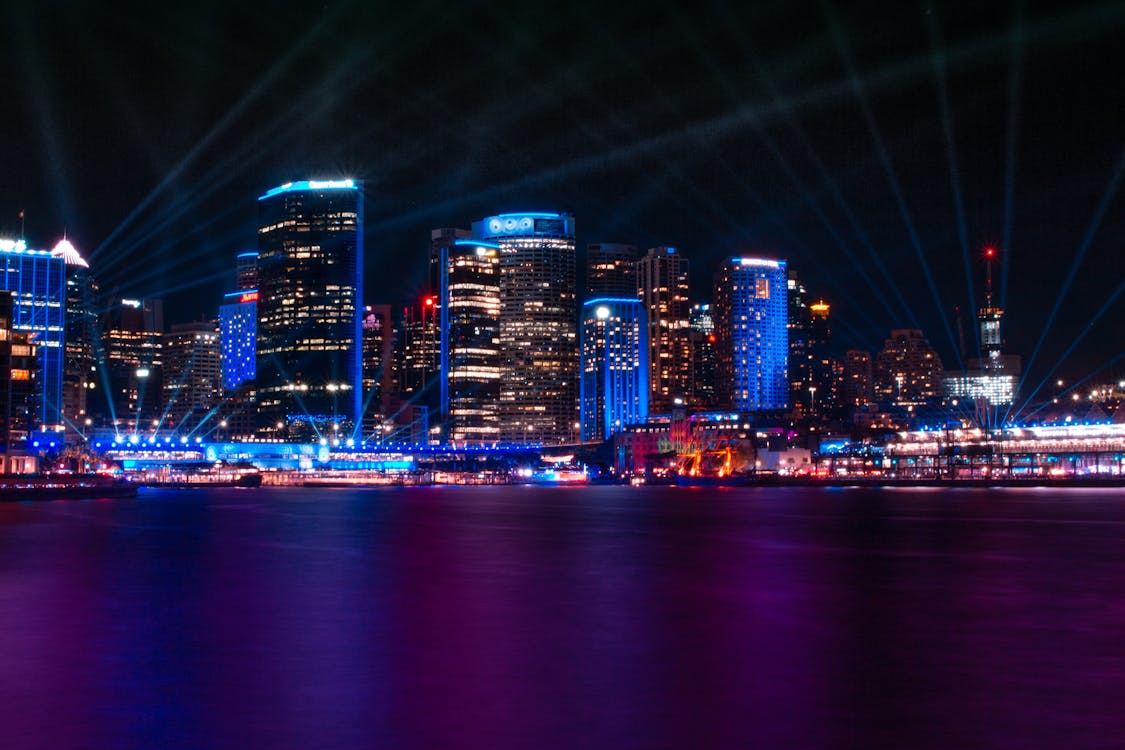 Illuminated City With Contemporary Architecture And River At Night