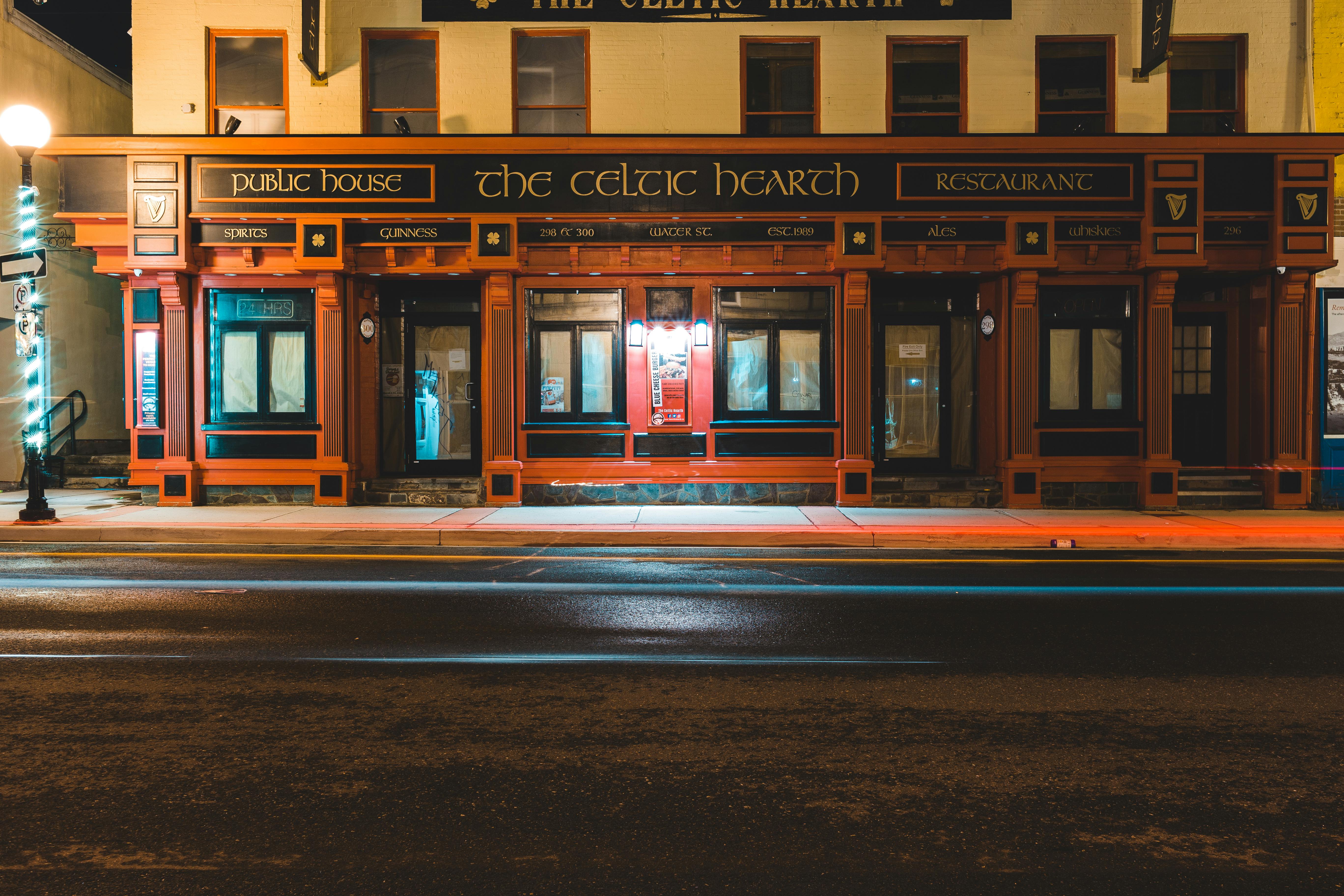 Entrance and signboard of historical restaurant at night · Free Stock Photo