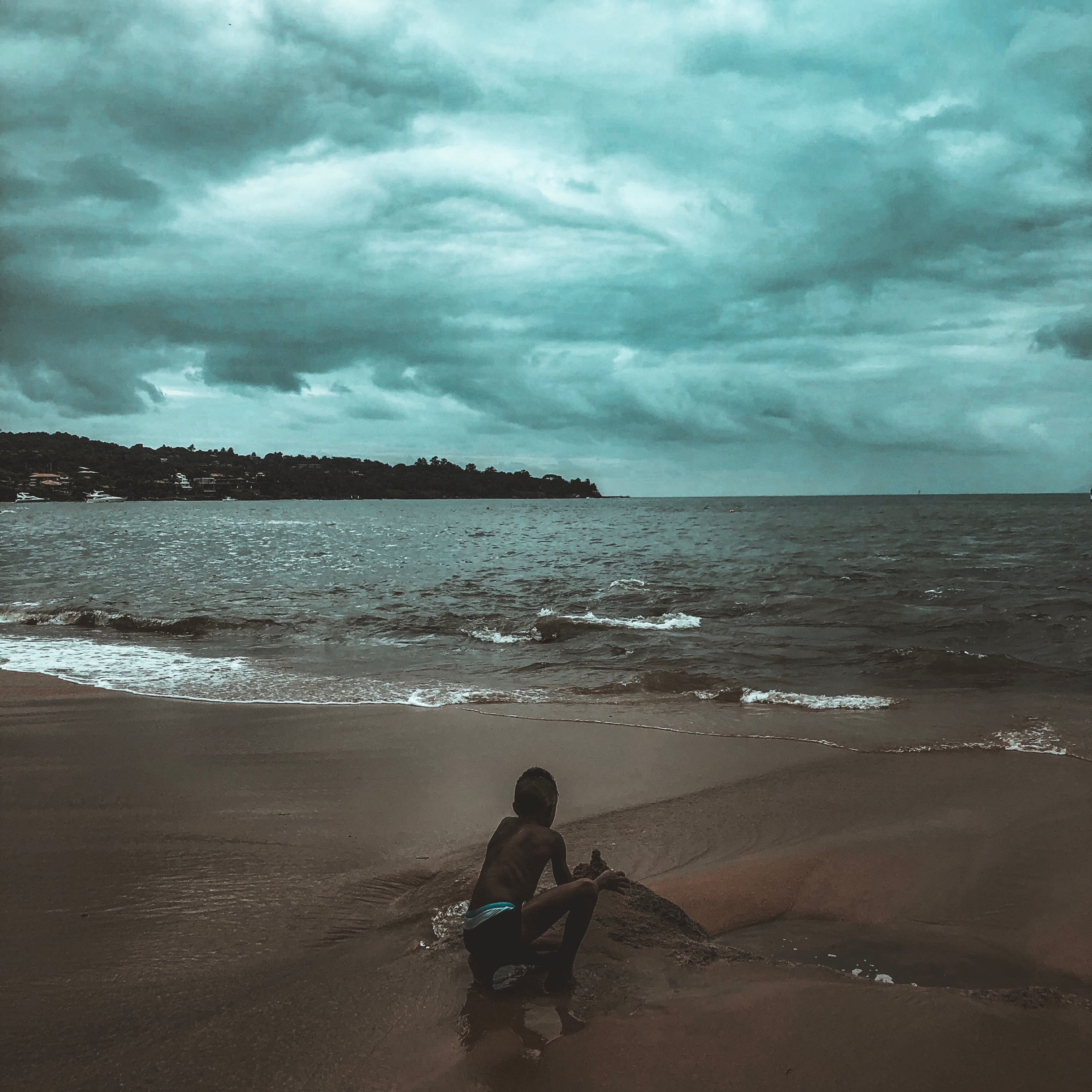 Photo Of Boy On Seashore · Free Stock Photo