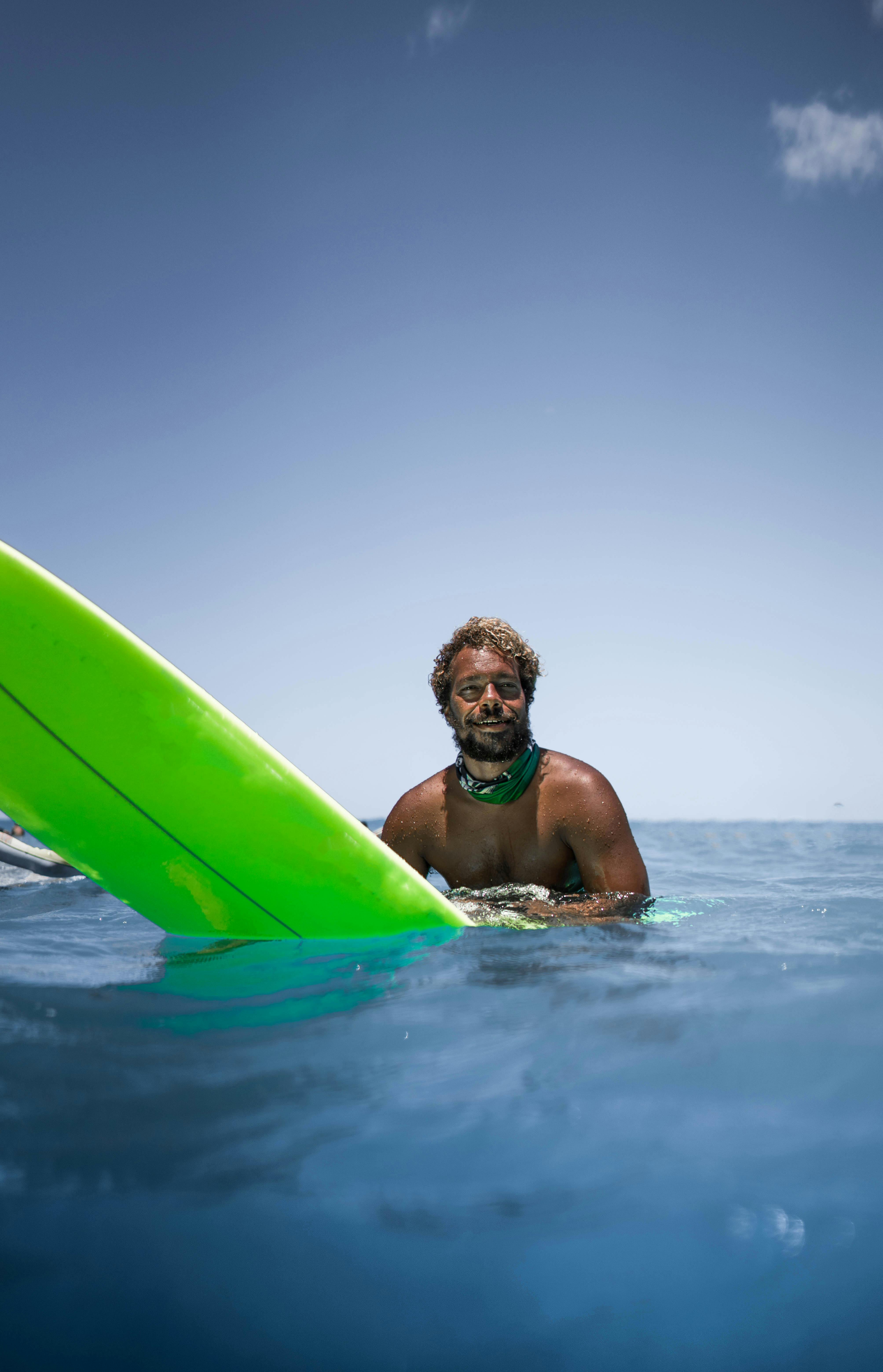 Photo Of Man Riding Surfboard · Free Stock Photo