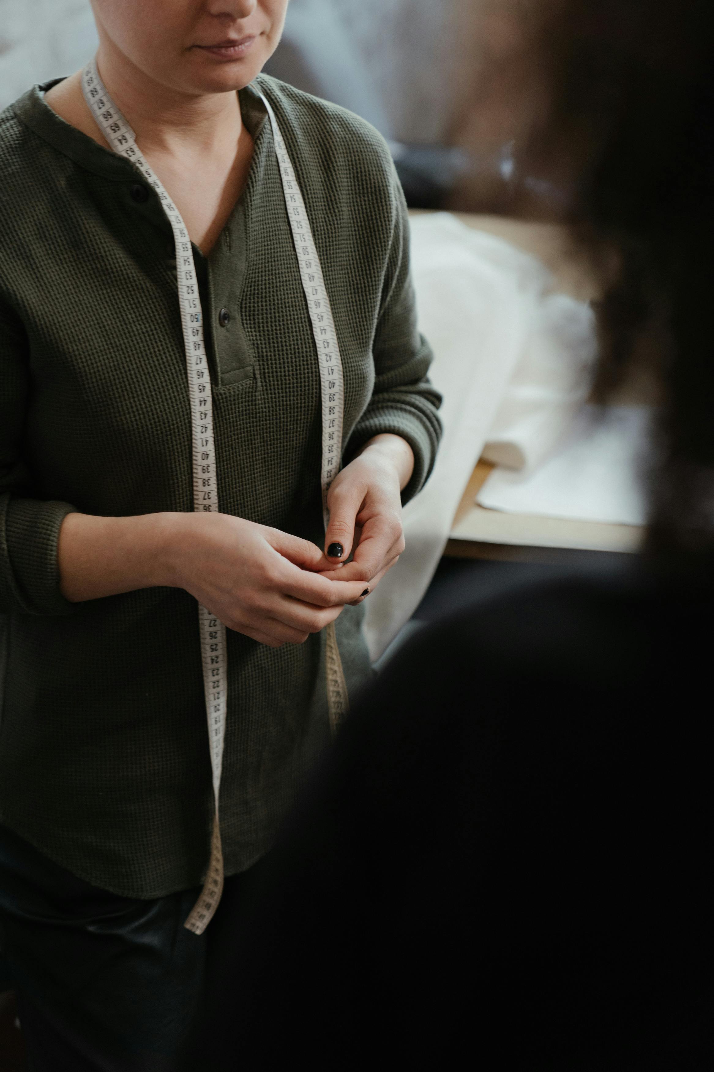A Seamstress Measuring her Client · Free Stock Photo