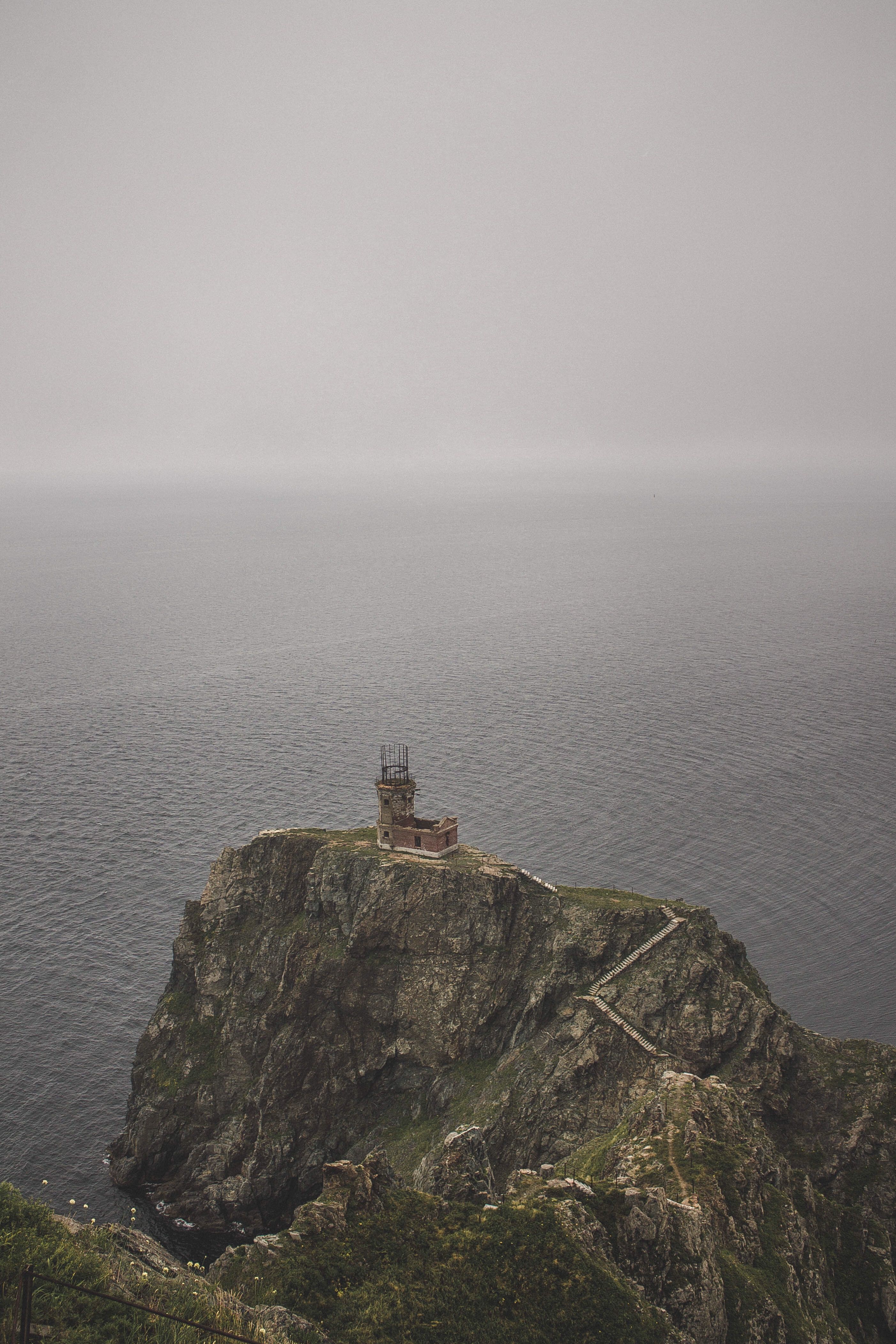 Structure on Rocky Cliff By the Sea · Free Stock Photo